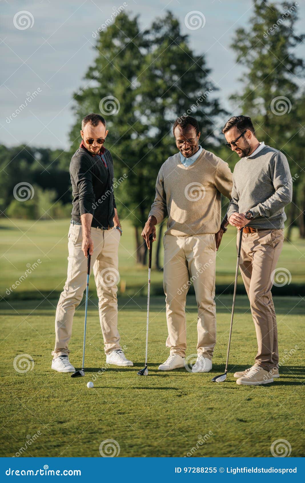 Multiethnic Friends Spending Time Together while Playing Golf on Golf ...