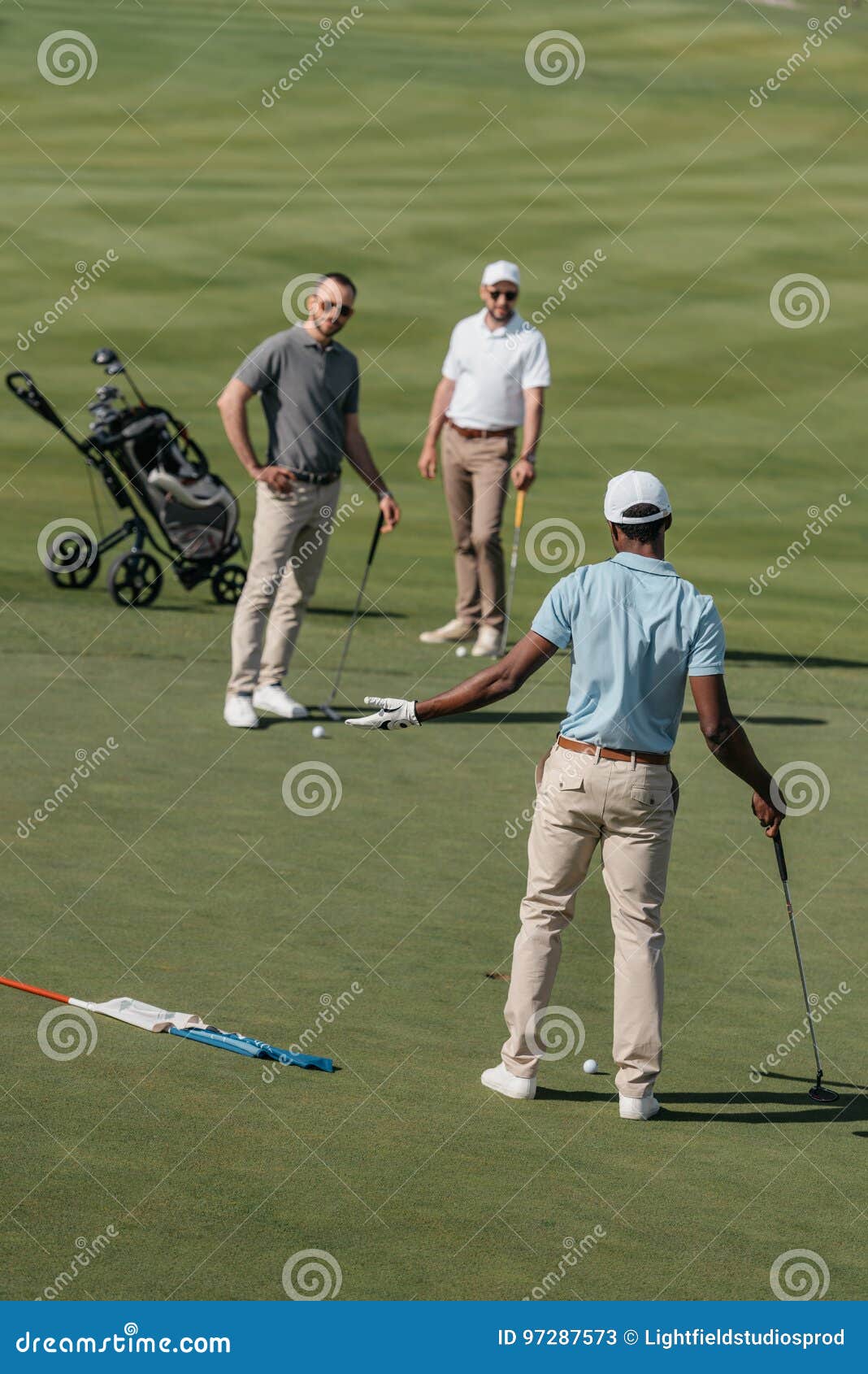 Multiethnic Golfers Talking during the Game on Green Pitch at Daytime ...