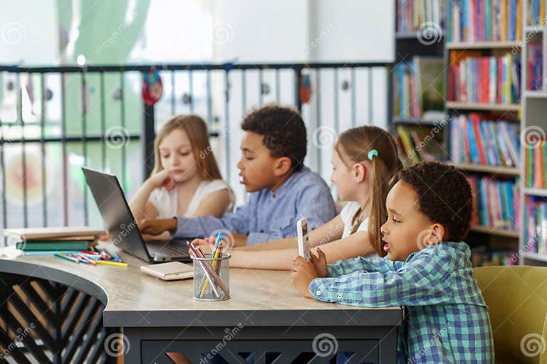 Multiracial Group of Children Sitting in Row at School Classroom and ...
