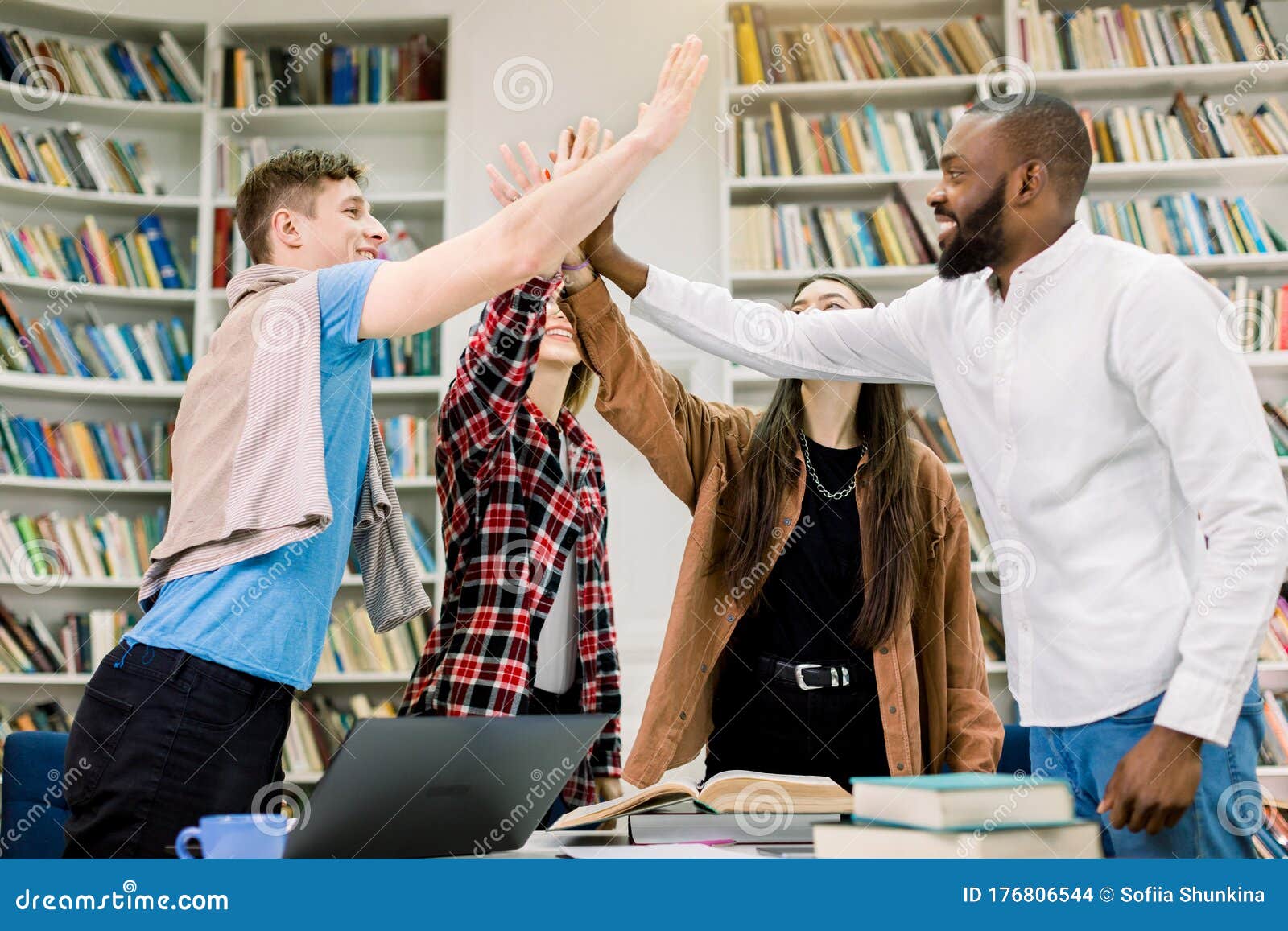 Multiethnic Group of Four Satisfied Pleasant Successful Students ...