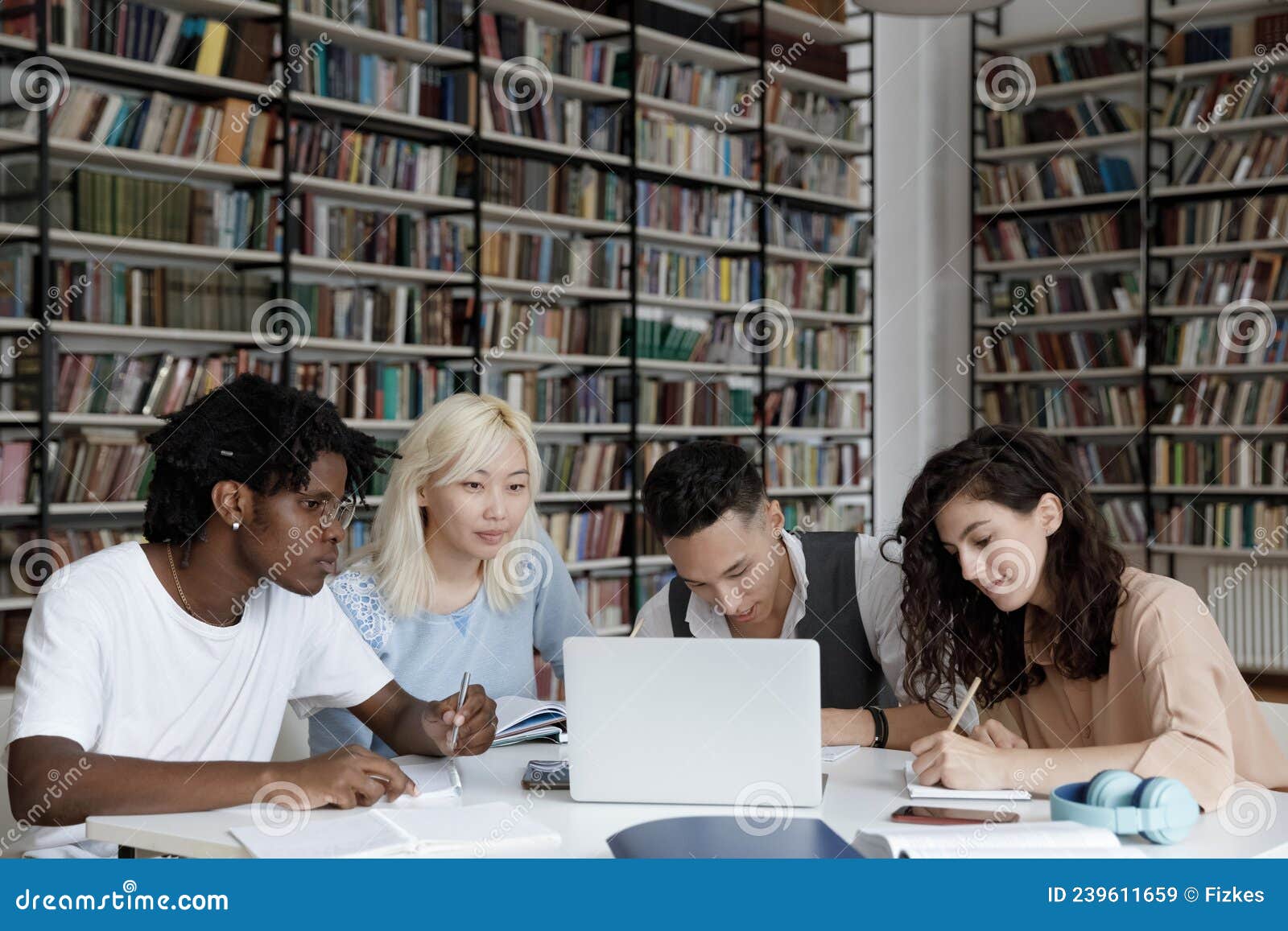 Multiethnic Group of University Students Working Together at Laptop ...