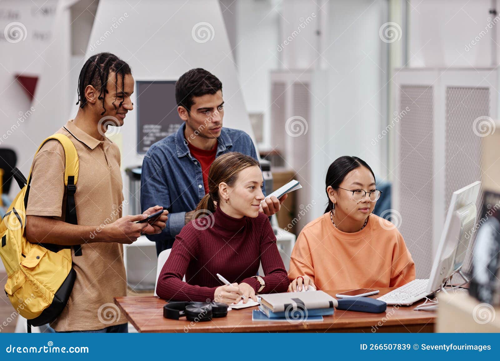 Multiethnic Group of Young People Studying Using Computer Together ...