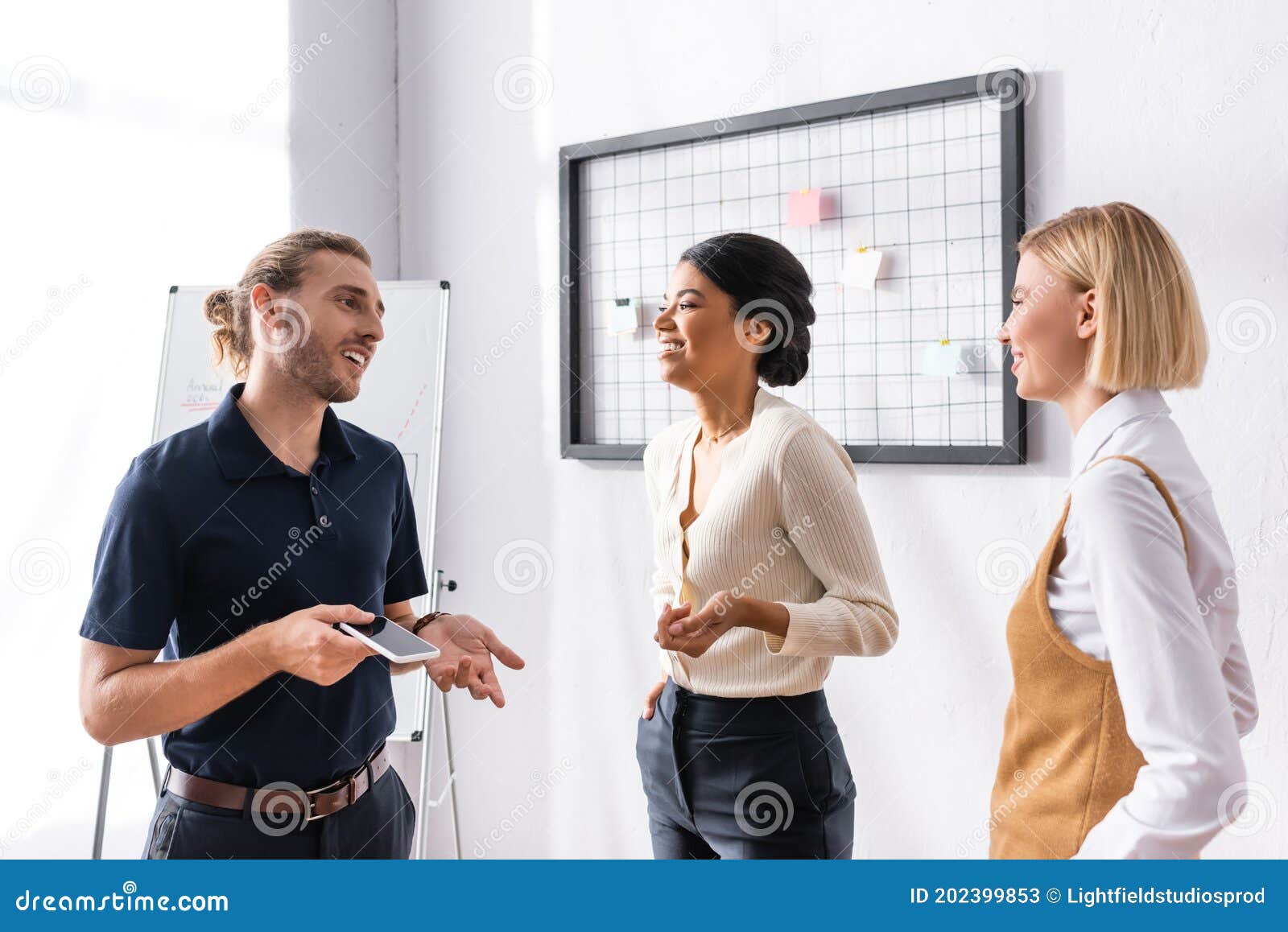 Multiethnic Office Workers Talking while Standing Stock Image - Image ...