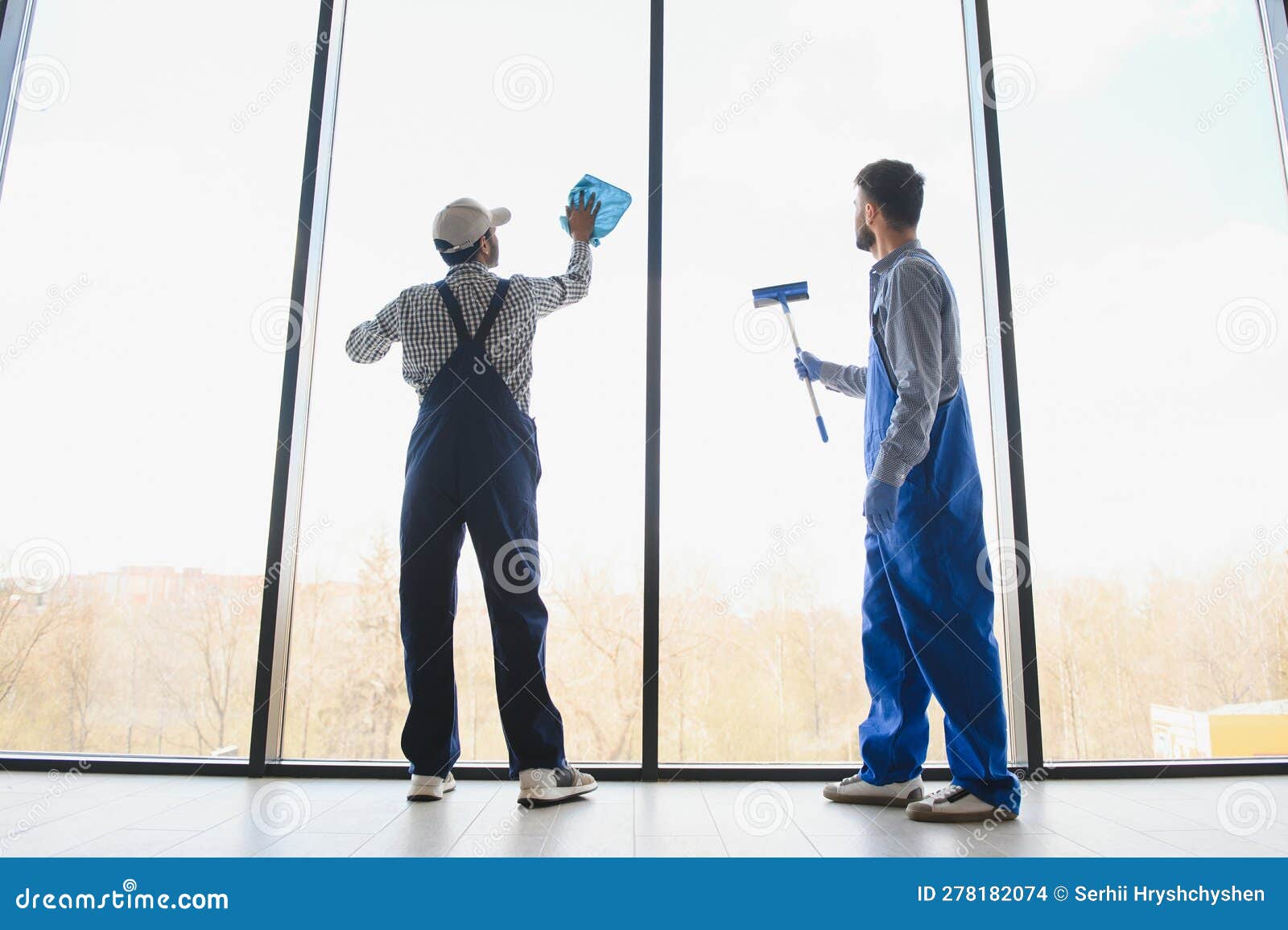 Multiethnic Professional Cleaners in Uniform Washing Large Windows in ...