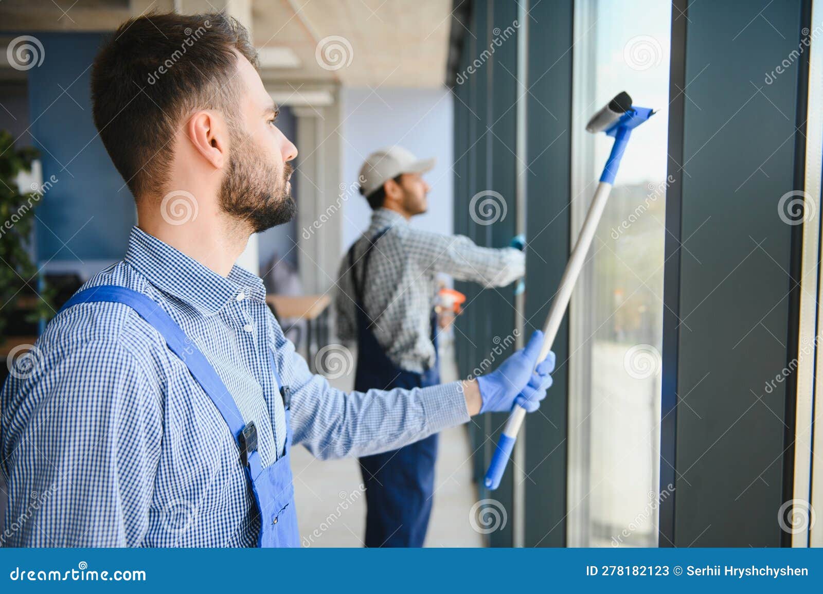 Multiethnic Professional Cleaners in Uniform Washing Large Windows in ...