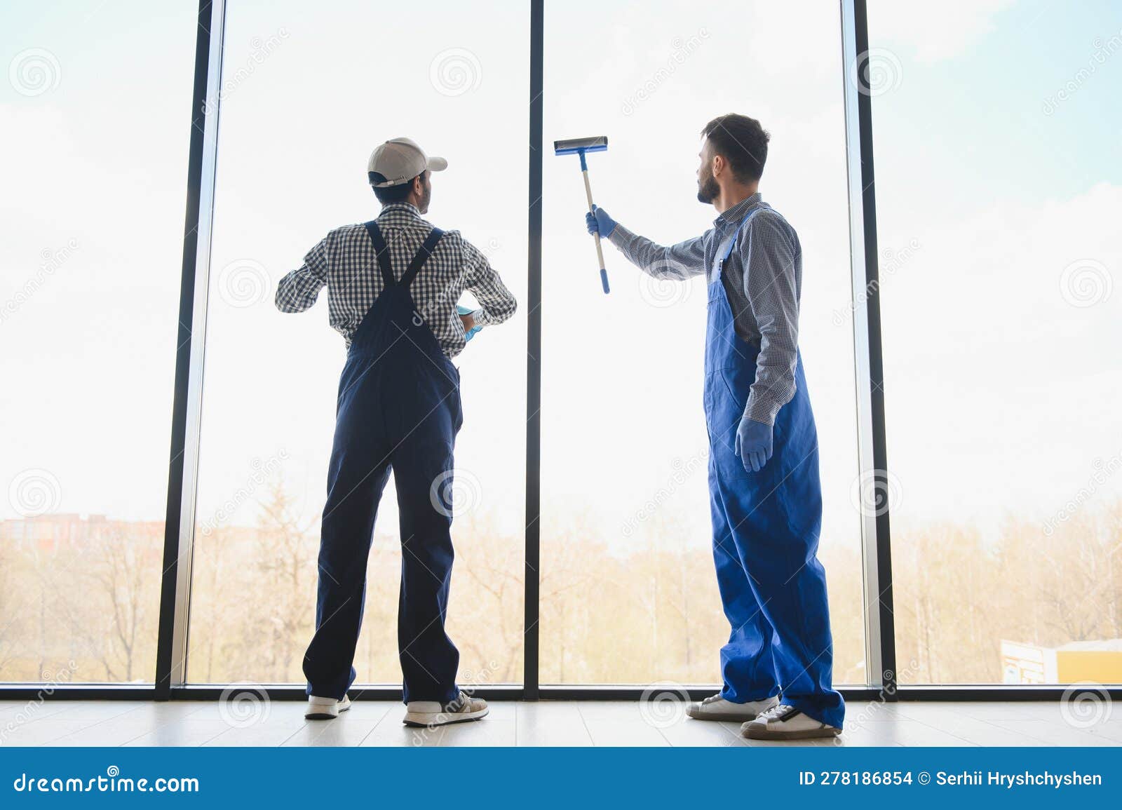 Multiethnic Professional Cleaners in Uniform Washing Large Windows in ...
