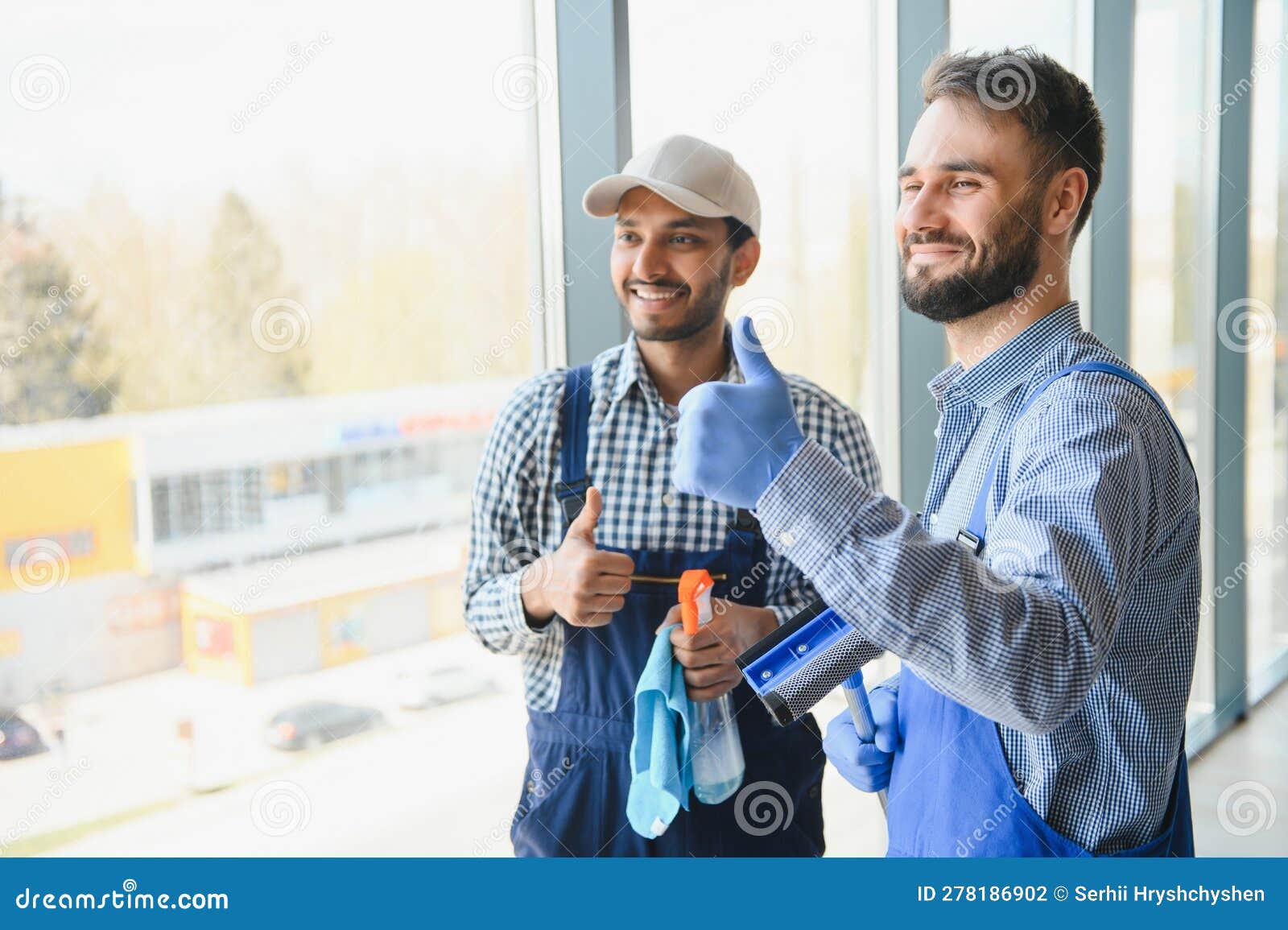 Multiethnic Professional Cleaners in Uniform Washing Large Windows in ...