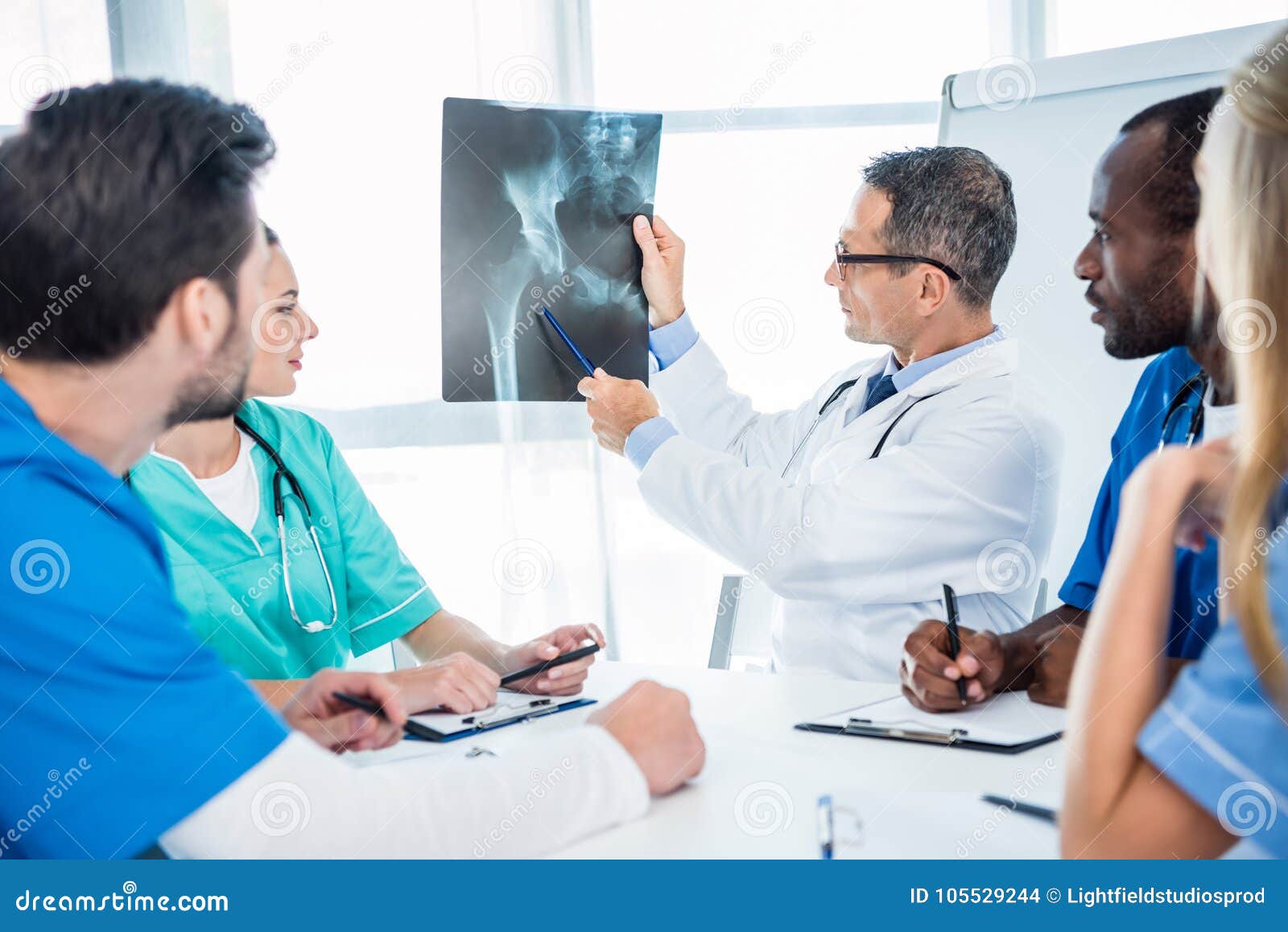 Team of Doctors Looking at X-ray Scan Stock Photo - Image of clipboard ... Team of Doctors Looking at X-ray Scan Stock Photo - Image of clipboard ...