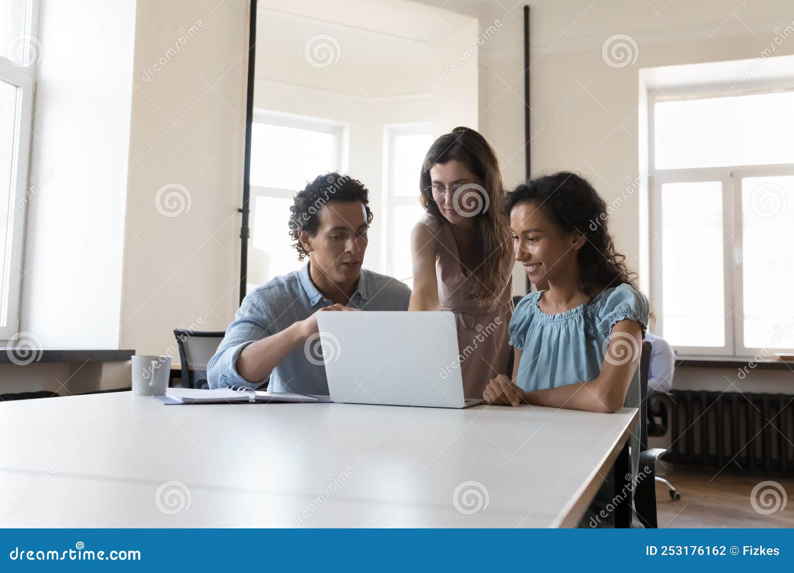 Multiethnic Teammates Look at Laptop Screen Working on Corporate Task ...