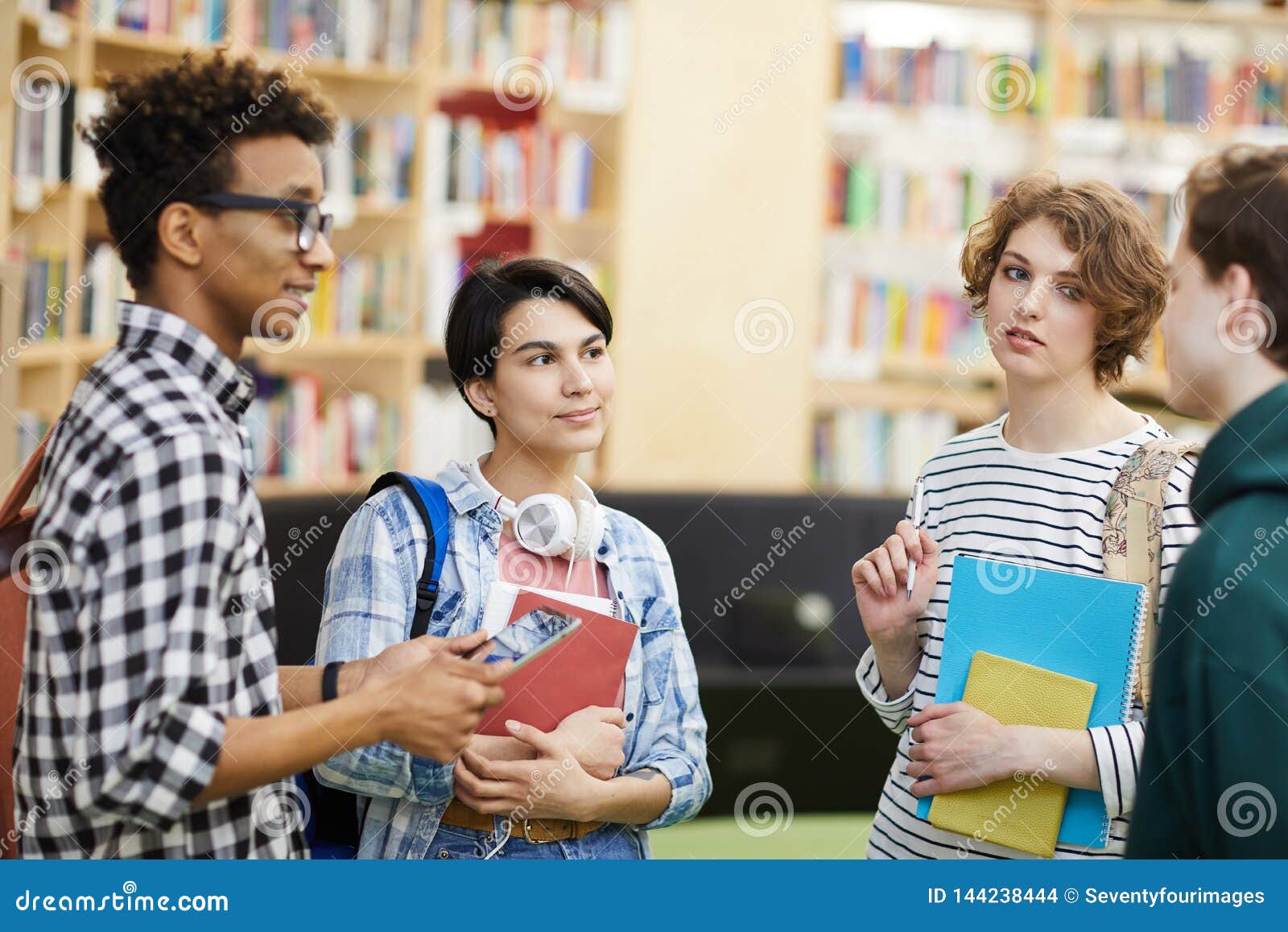 Multiethnic University Students Talking in Library Stock Photo - Image ...