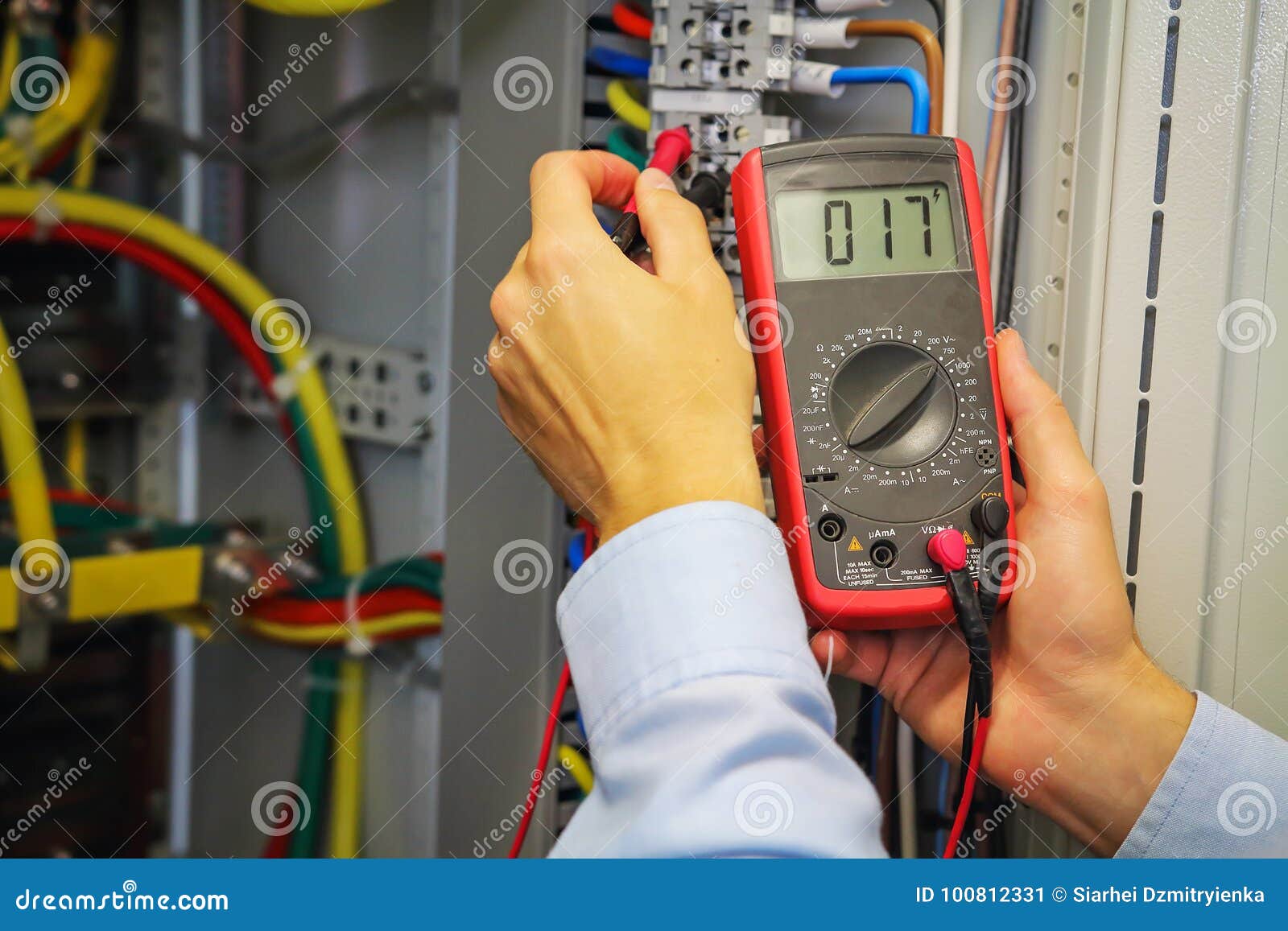 Multimeter in Hands of Electrician. Engineer Adjust Electric Panel ...