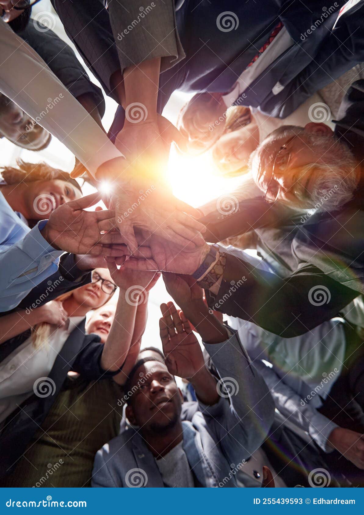 Multinational Business Team Looking Down Putting Hands Together Stock ...