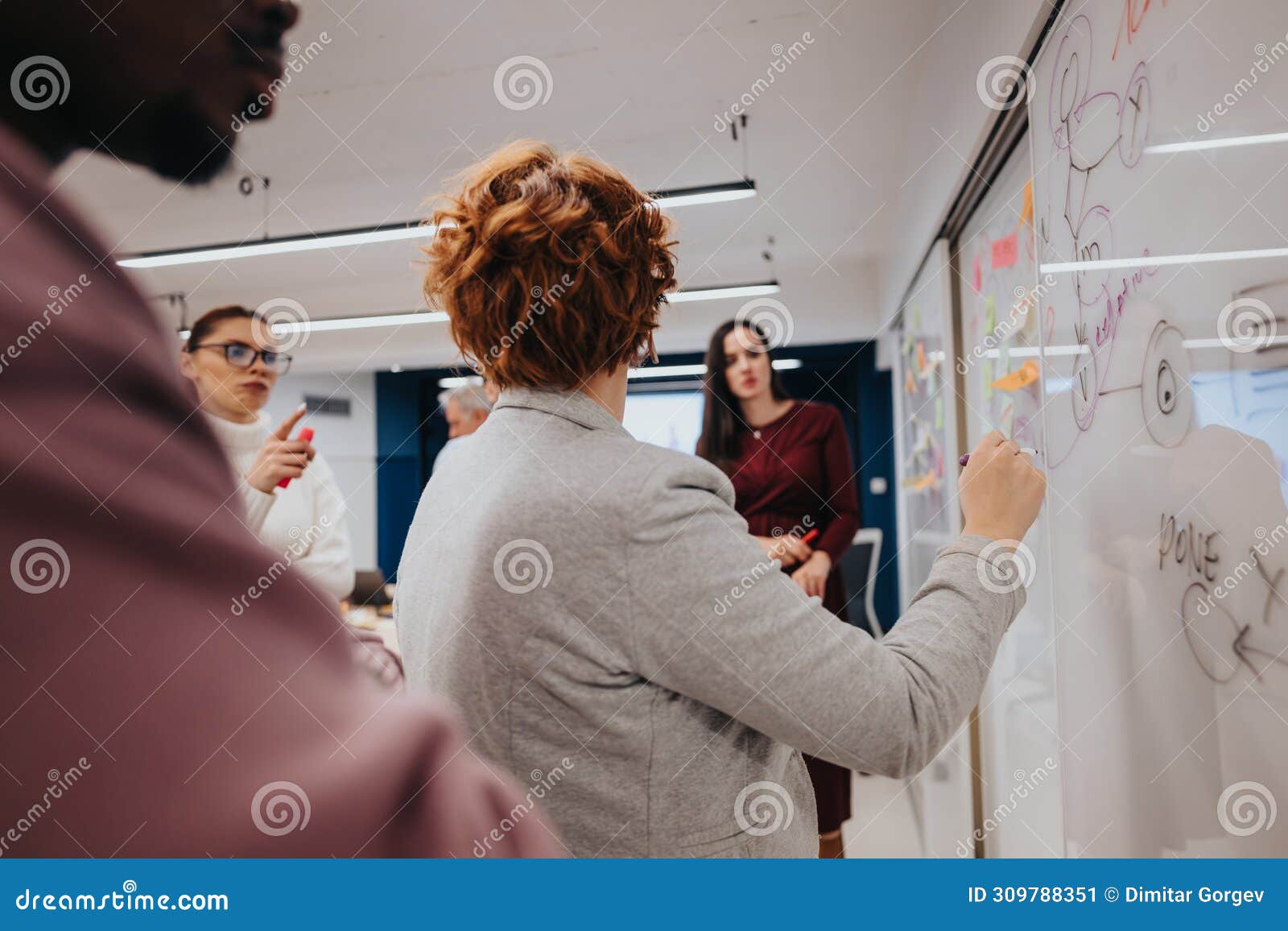 Multinational Colleagues Collaborate in a Classroom, Sharing Ideas and ...