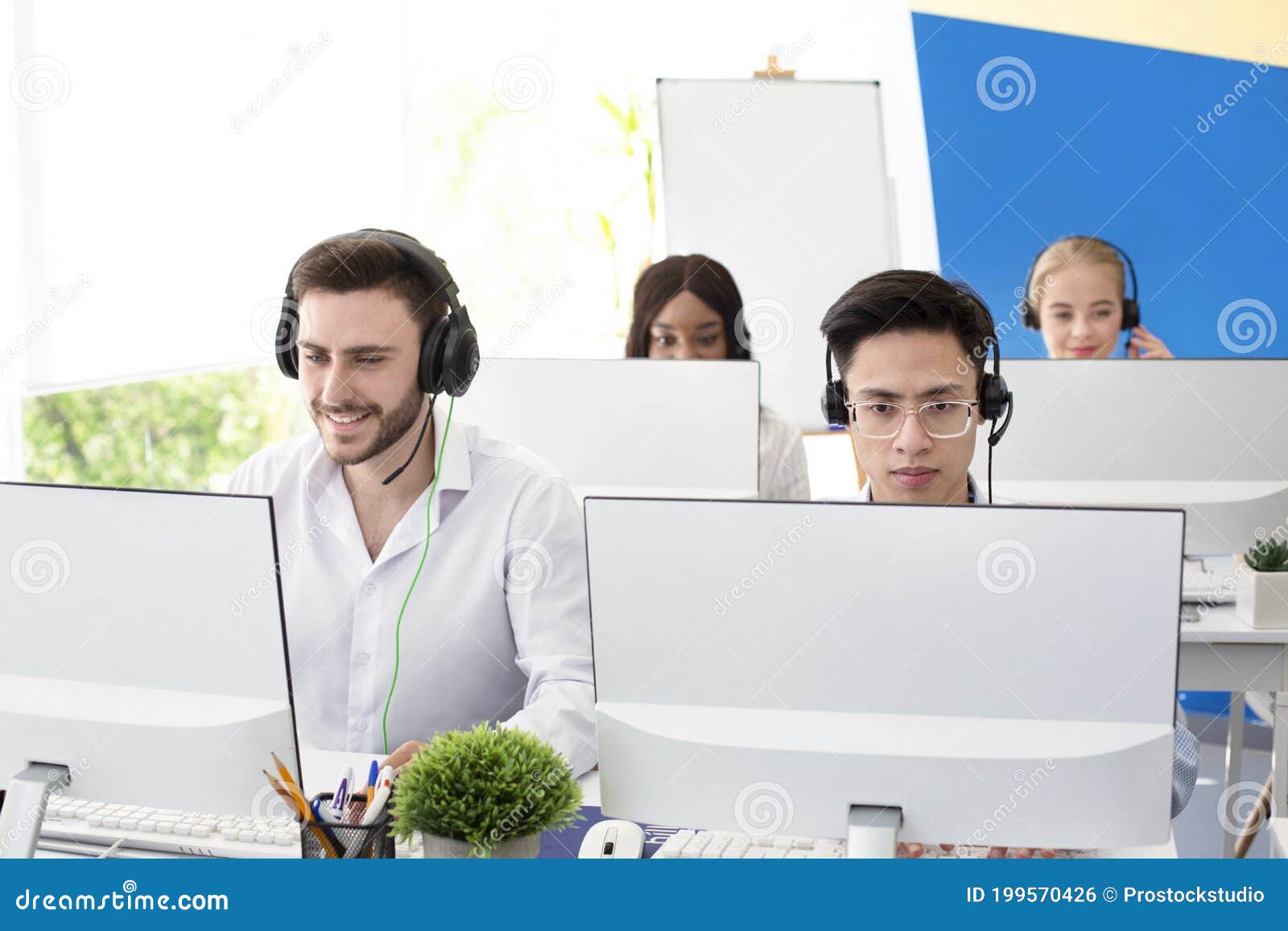 Multinational Customer Service Representatives in Headsets Working ...