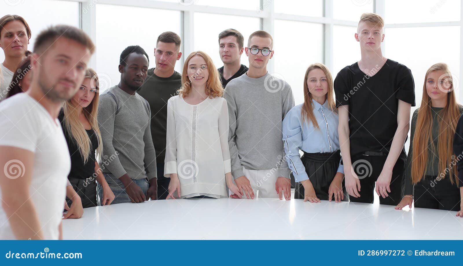 Multinational Group of Students Standing Near a Round Table Stock Photo ...