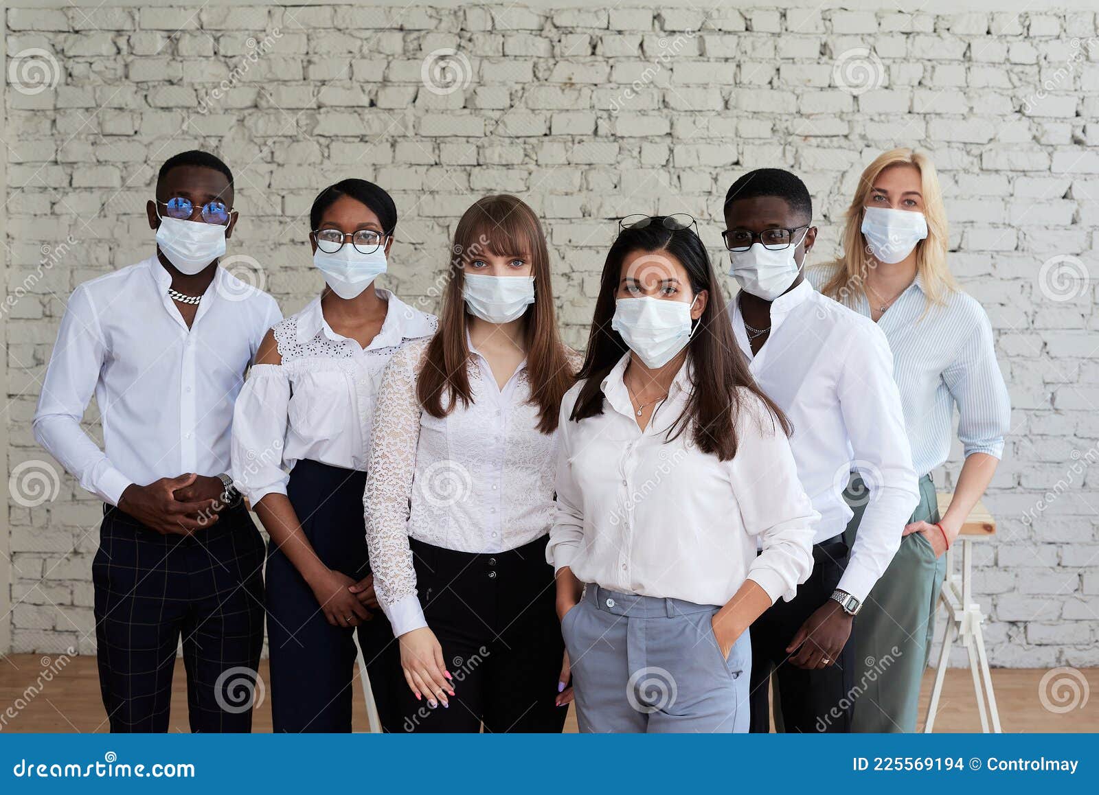 Multinational Office Workers Stand in Protective Masks and Look at the ...