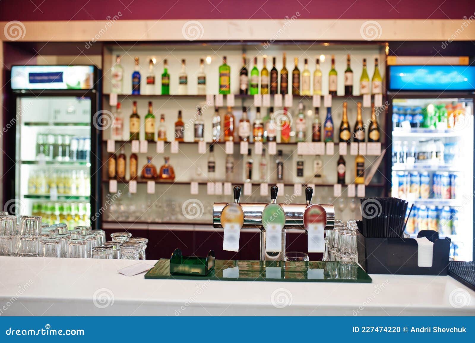 Multiple Beer Taps in a Row Against Bar with Bottles Stock Photo ...