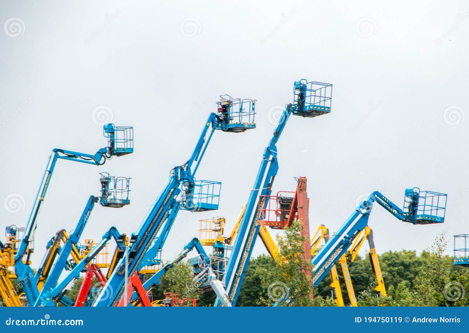 Two Cherry Pickers Inside A Concrete Building Under Construction Behind ...