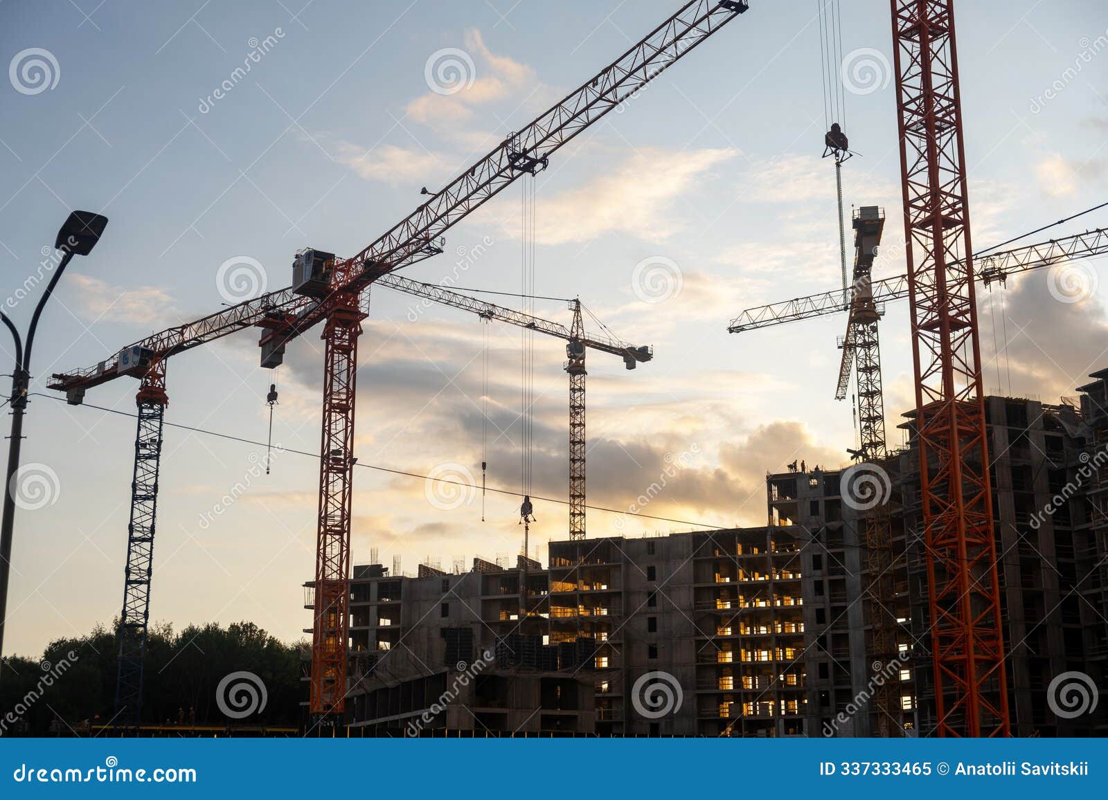 Multiple Cranes Operate Efficiently at a Bustling Construction Site ...