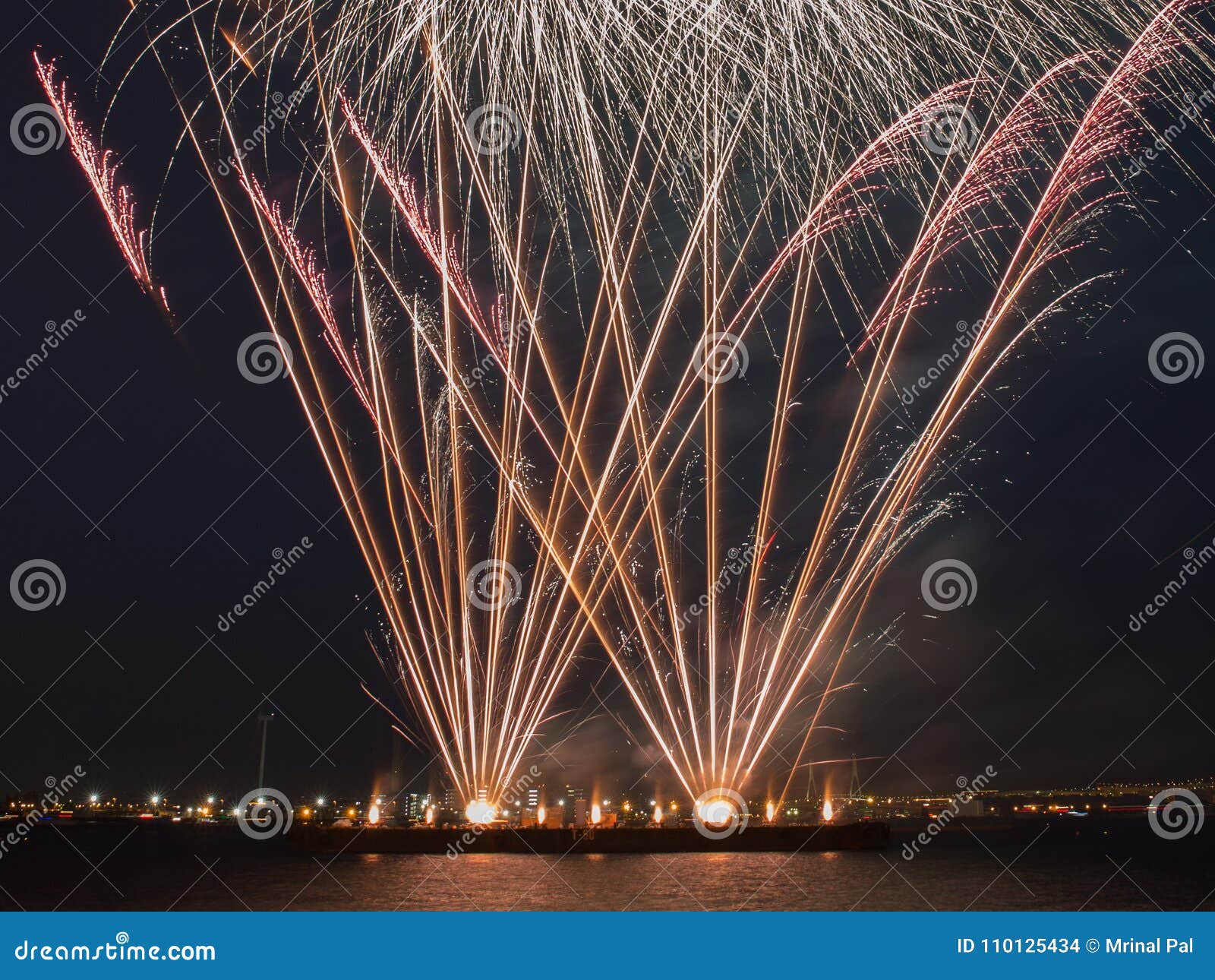 Multiple Fireworks Burst in the Night Sky with Light Trails Stock Photo ...