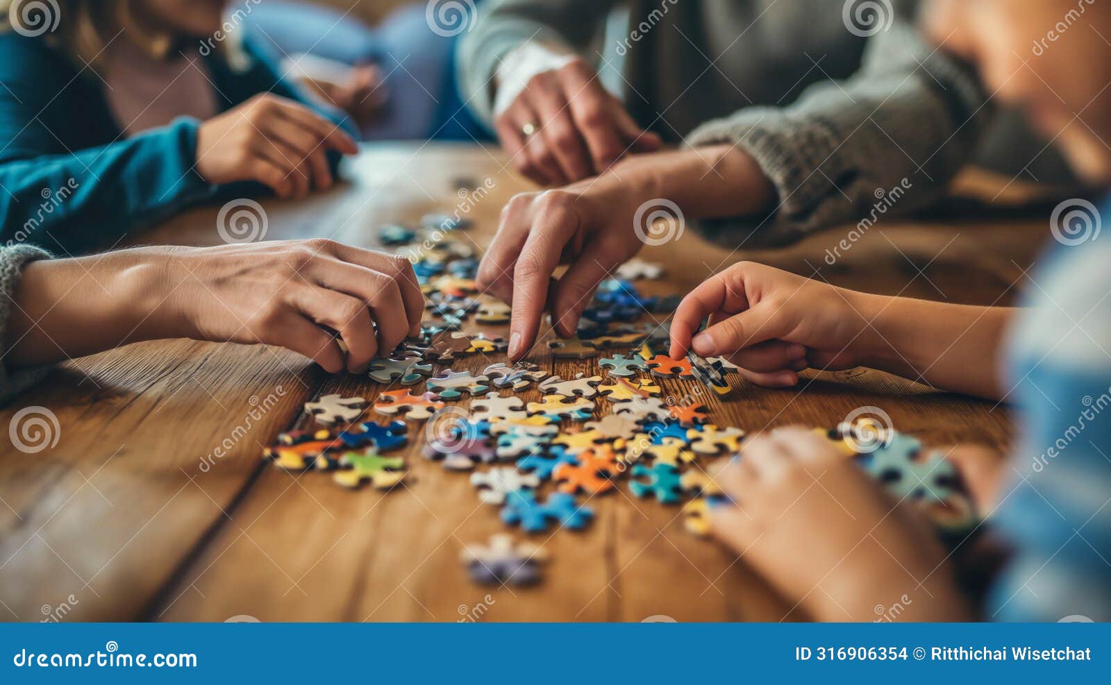 Multiple Hands of Different Ages Collaborate on Assembling a Colorful ...