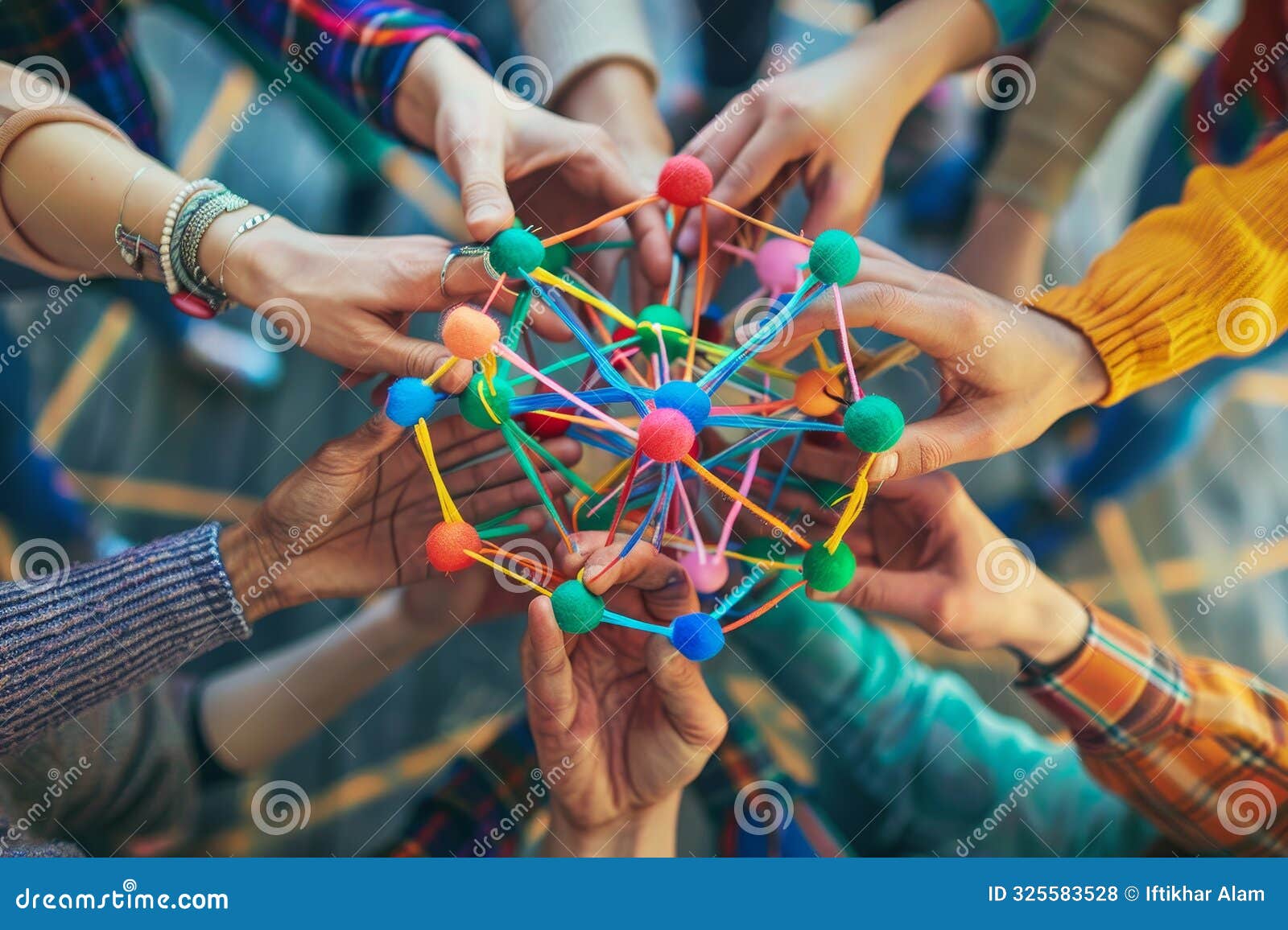 Multiple Hands Reach Out To Hold a Vibrant, Multi-colored Structure ...