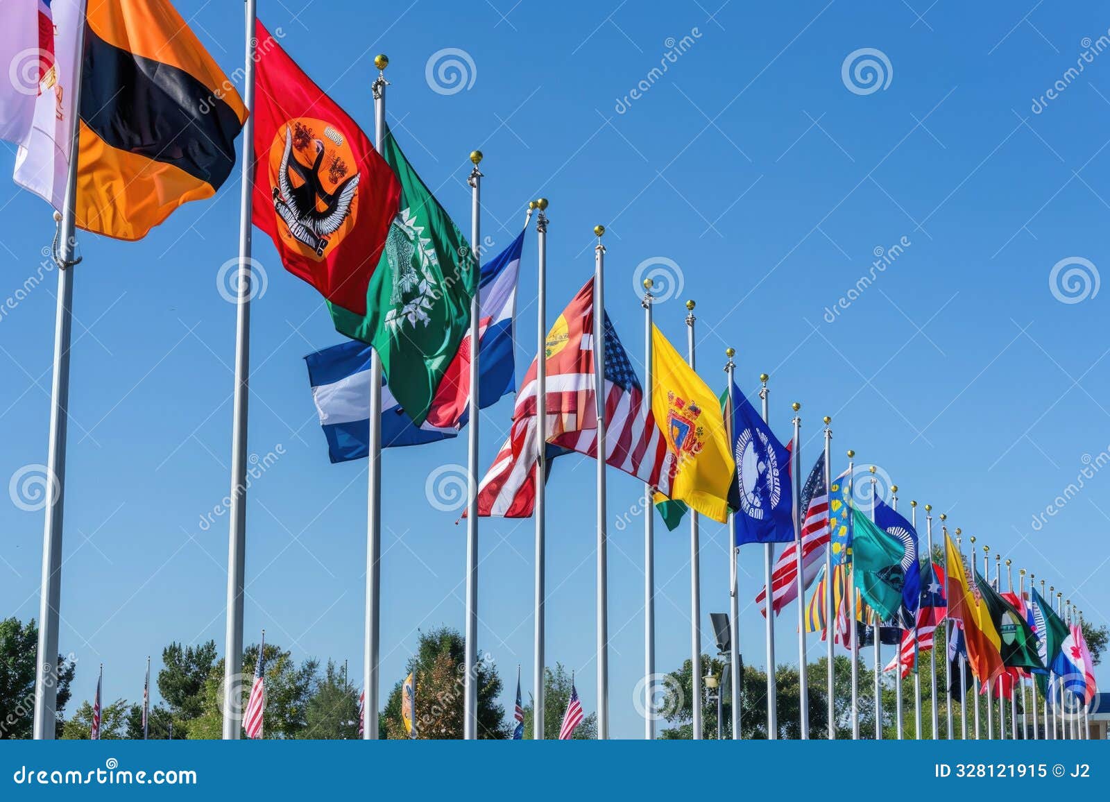Multiple International Flags Waving on Tall Flagpoles Against a Clear ...