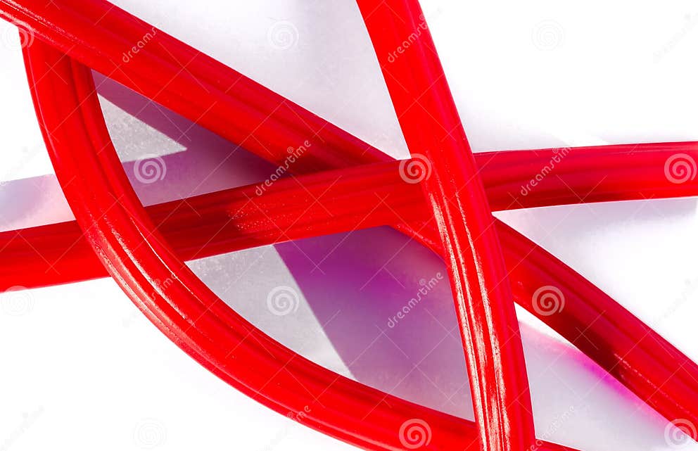 Intertwined Red Licorice Sticks on White Background Stock Image - Image ...