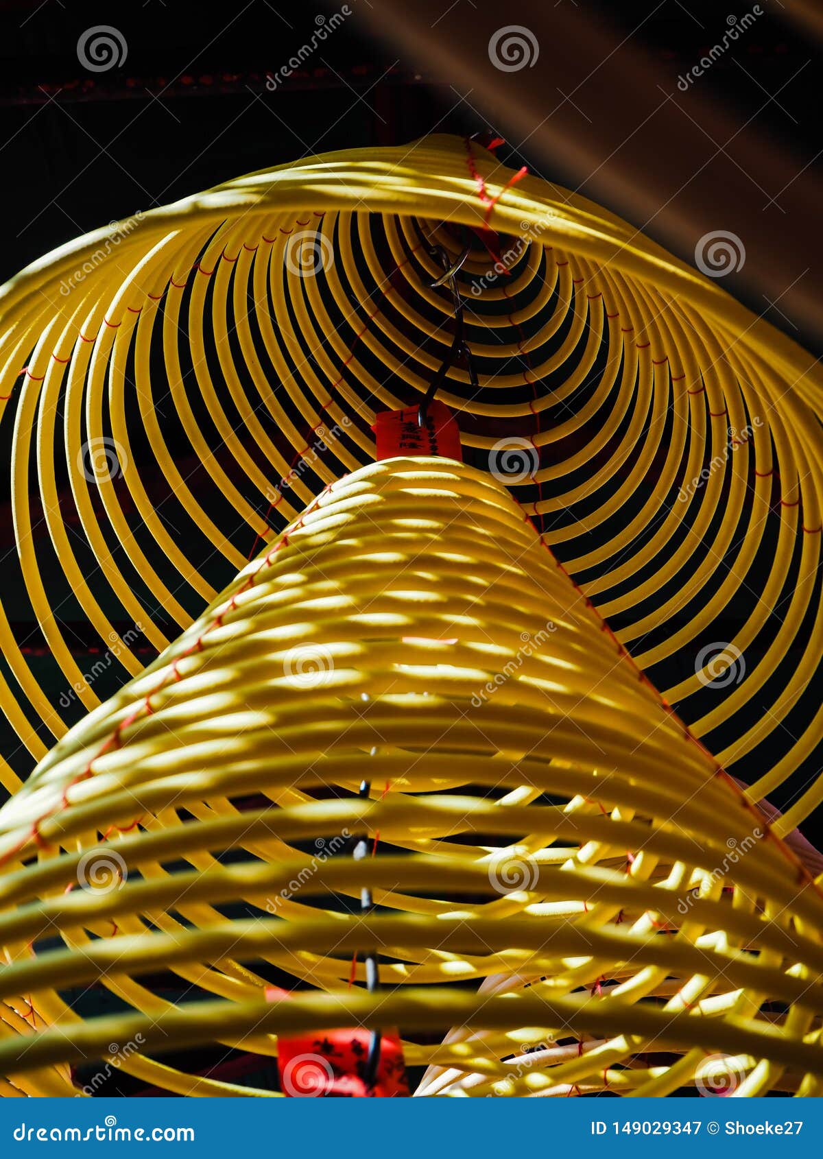 Multiple Large Yellow Incense Coils Hanging in Stacks from the Ceiling ...
