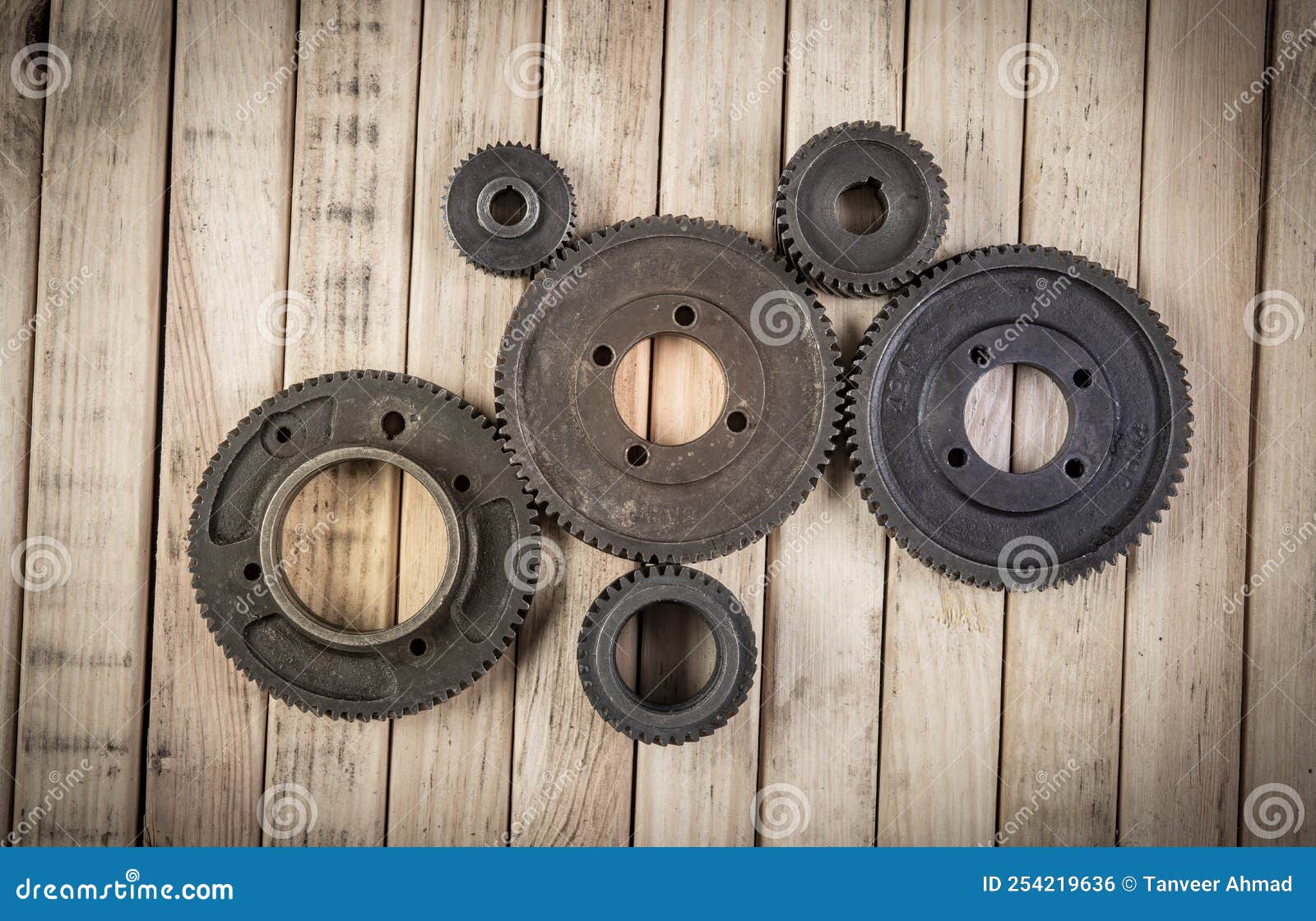 Multiple Size Gears Joining Each Other on Wooden Table Top View Stock ...
