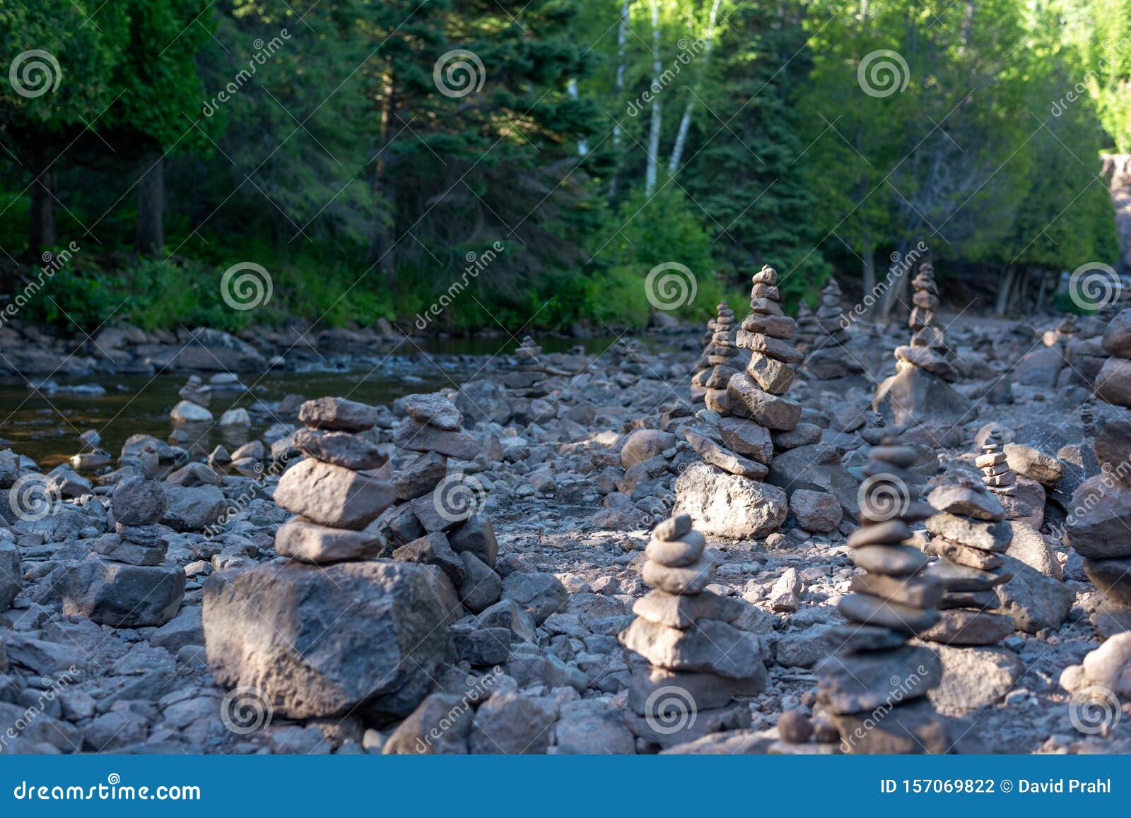 Rows of Stone Cairns Along Peaceful Forest Stream Stock Photo - Image ...