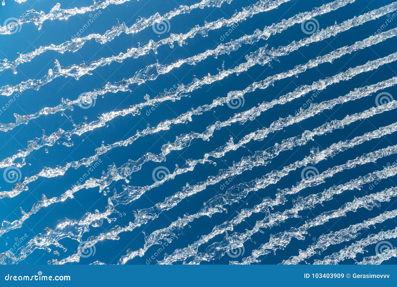 Water jets over a blue sky stock image. Image of movement - 103403909