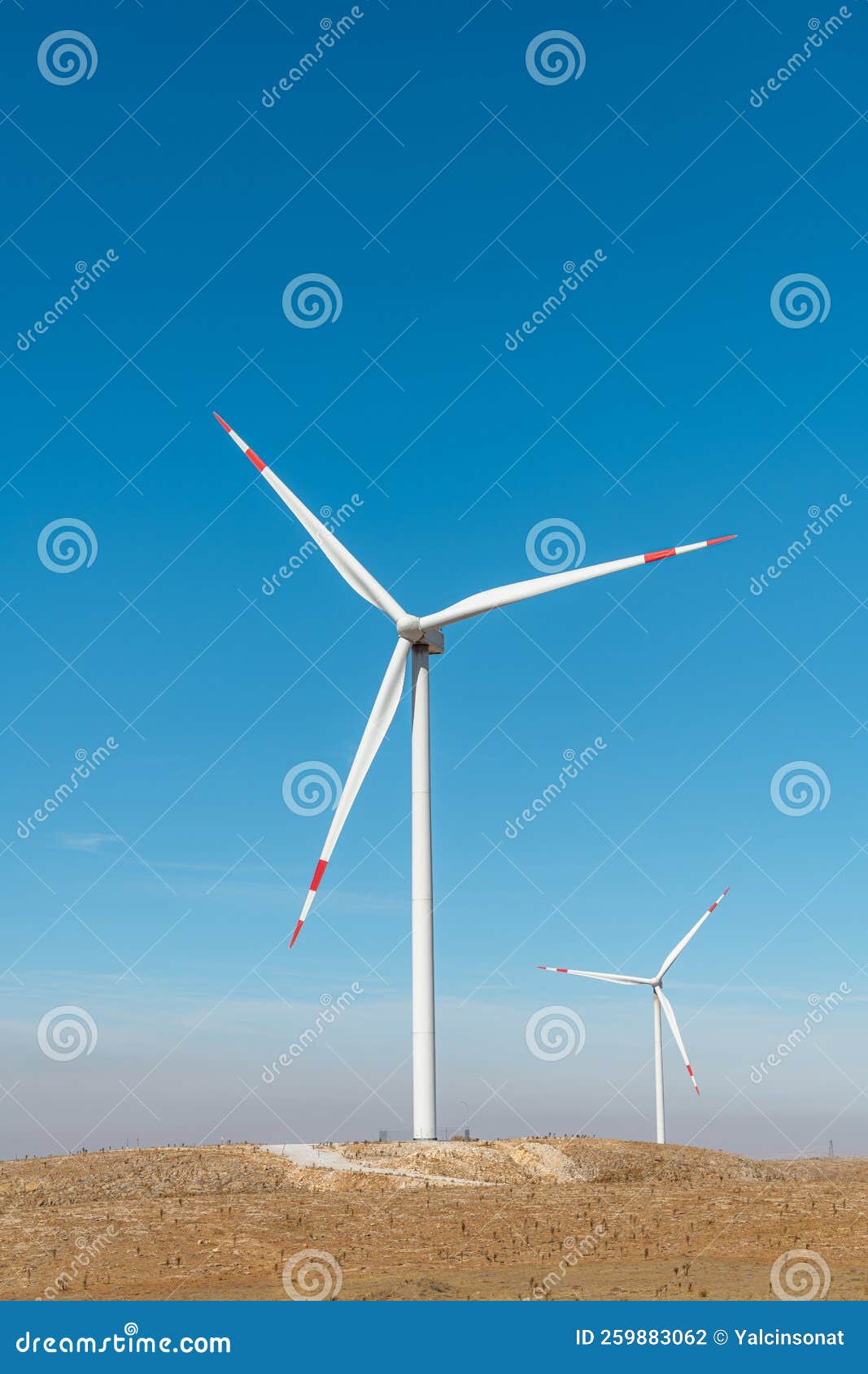 Multiple Wind Turbines Standing on a Hill at Sunrise and Generating ...