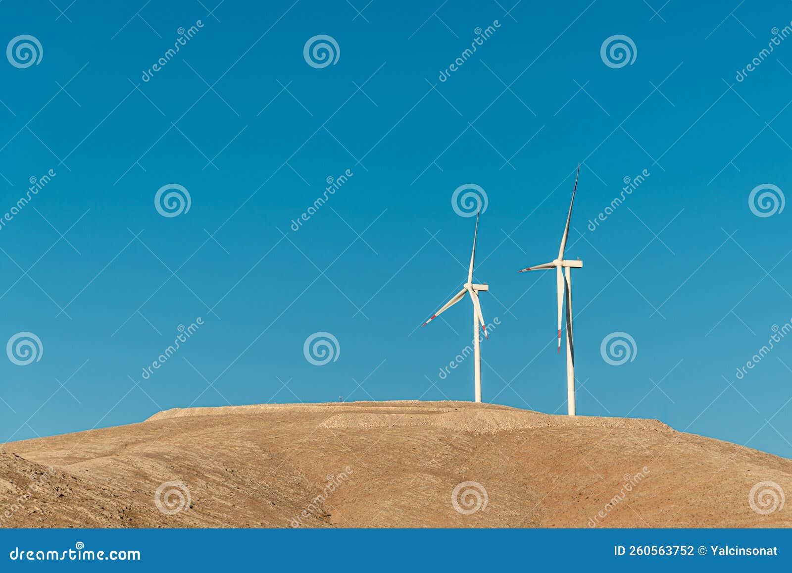 Multiple Wind Turbines Standing on a Hill at Sunrise and Generating ...