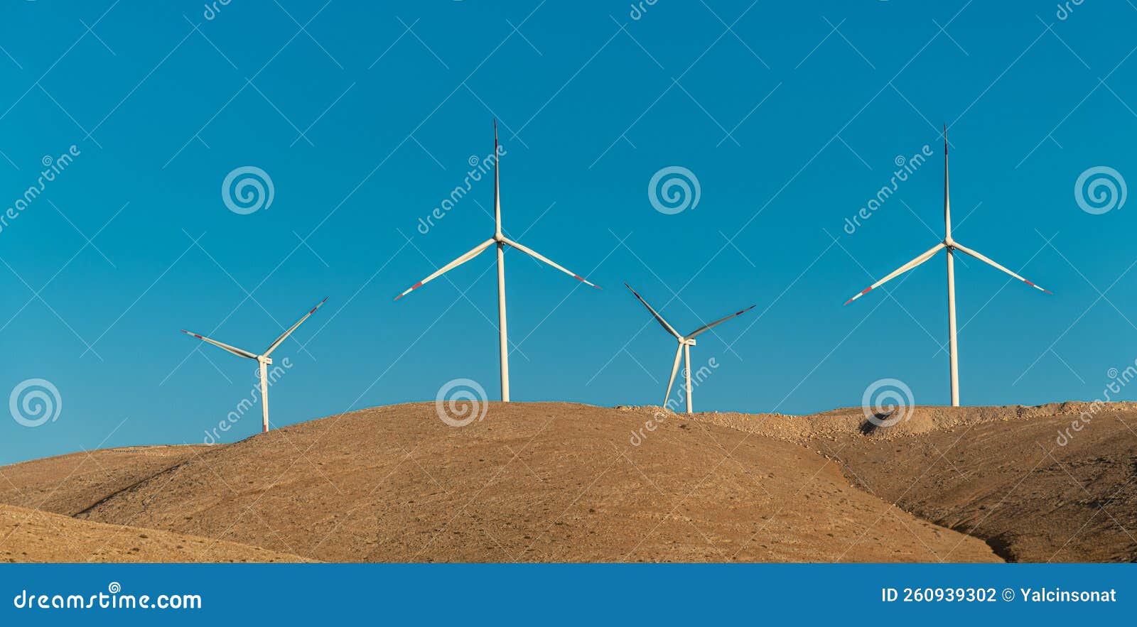 Multiple Wind Turbines Standing on a Hill at Sunrise and Generating ...