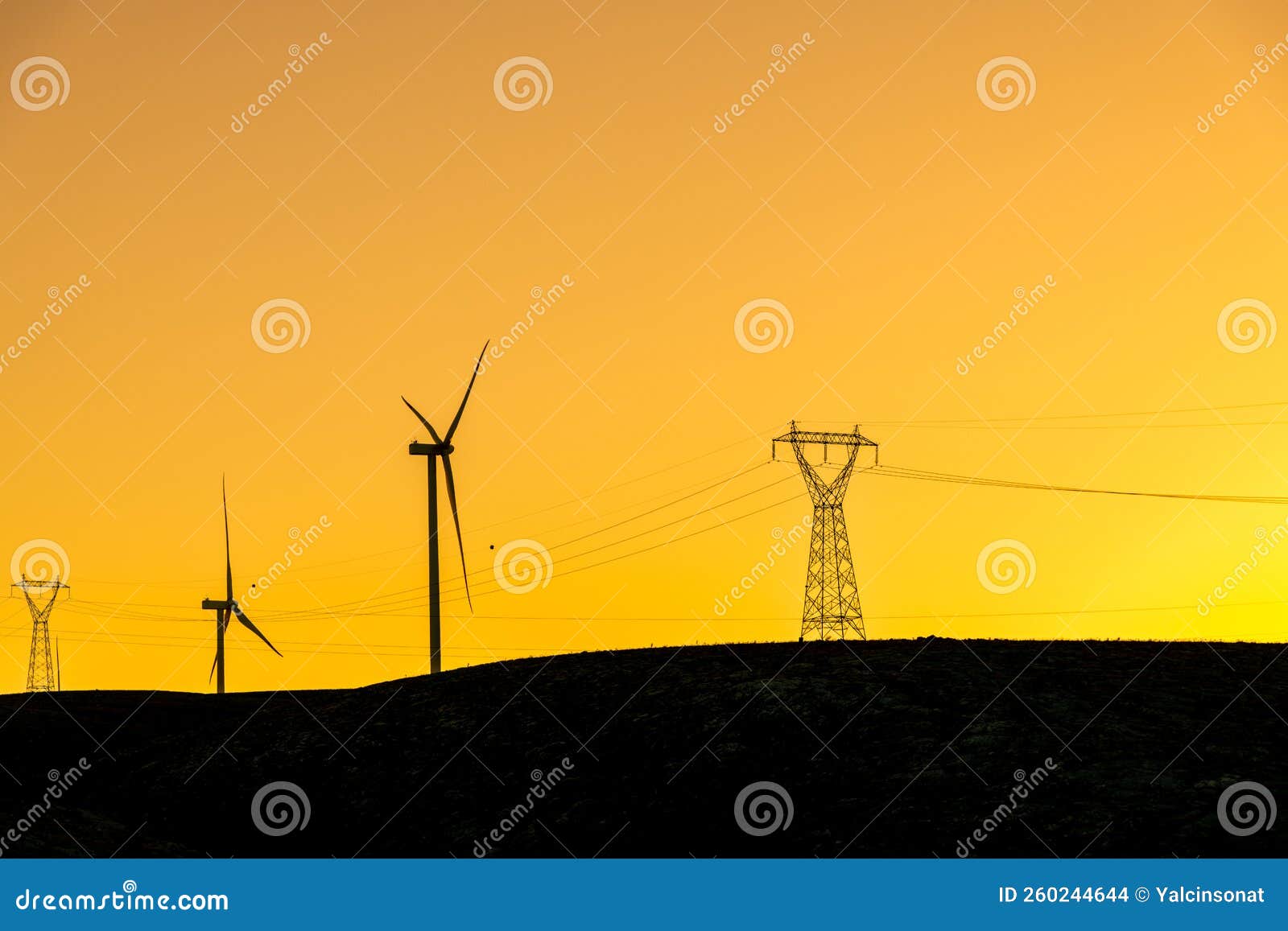 Multiple Wind Turbines Standing on a Hill at Sunset and Generating ...