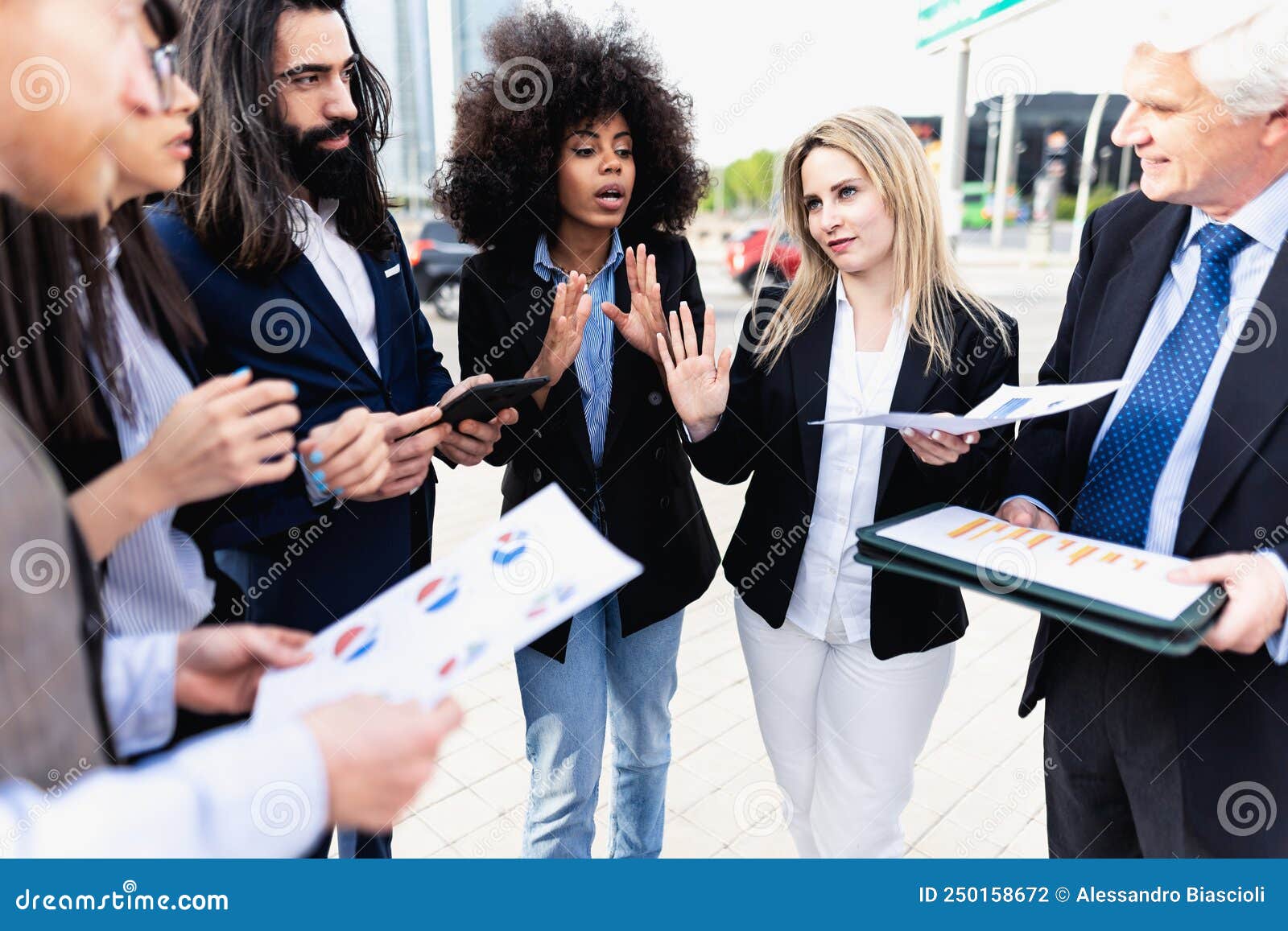 Multiracial Business People Having a Briefing Outside Office Stock ...