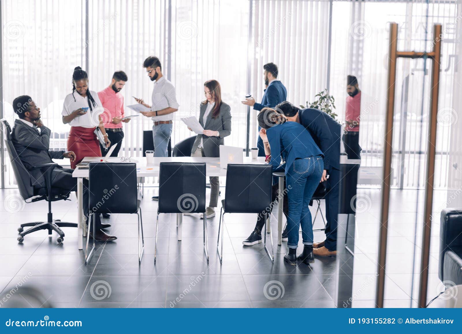 Diverse Smiling Businesspeople Having Conversation Standing Together at ...