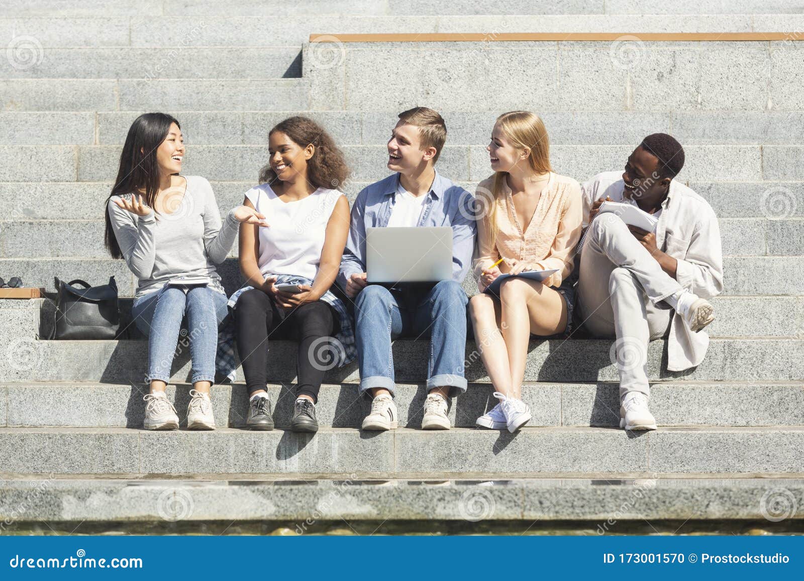 Multiracial Students Having Conversation while Studying in Park Stock ...