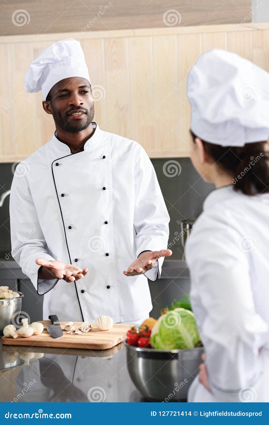 Multiracial Chefs Team Discussing Recipe and Cooking Stock Photo ...