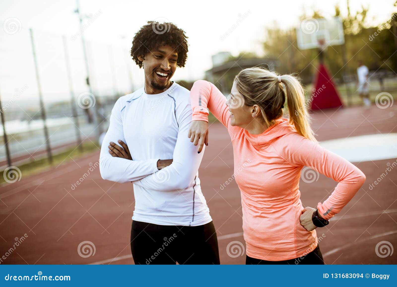 Multiracial Couple of Runners Resting after Training Stock Photo ...