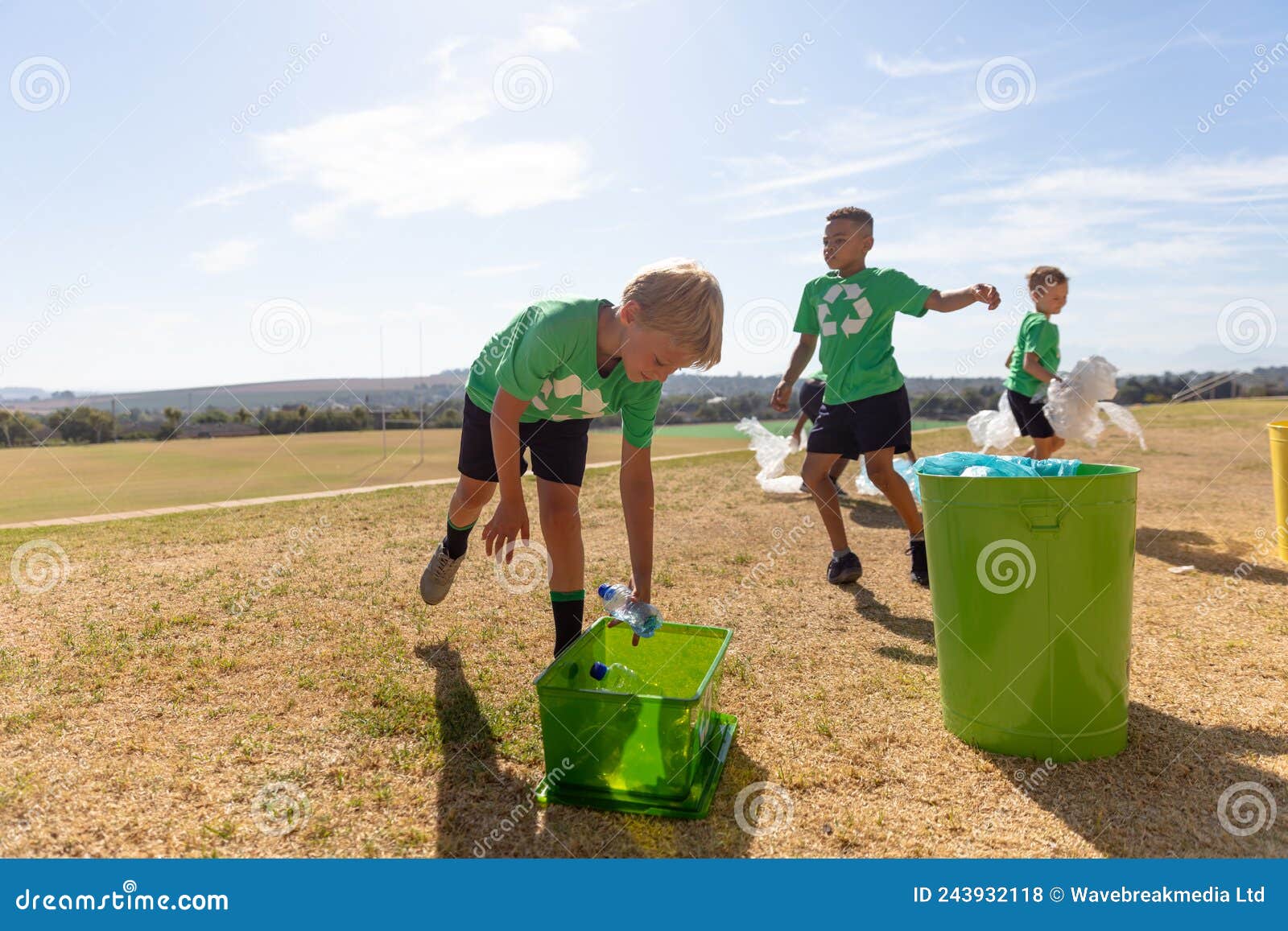 Multiracial Elementary Schoolboys Putting Plastic Garbage in Garbage ...