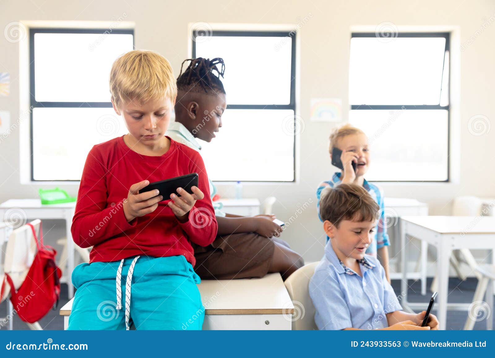 Multiracial Elementary Schoolboys Using Smartphone while Relaxing in ...