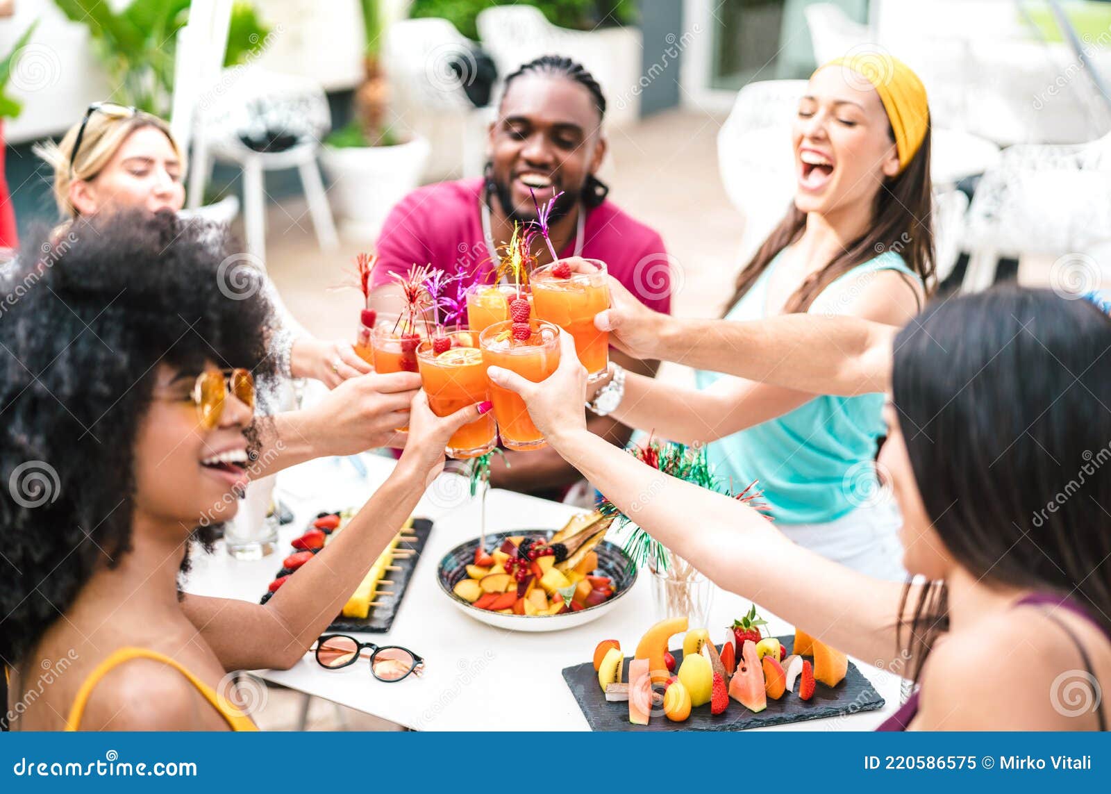 Multiracial Friends Toasting Sex On The Beach Fancy Cocktails Stock