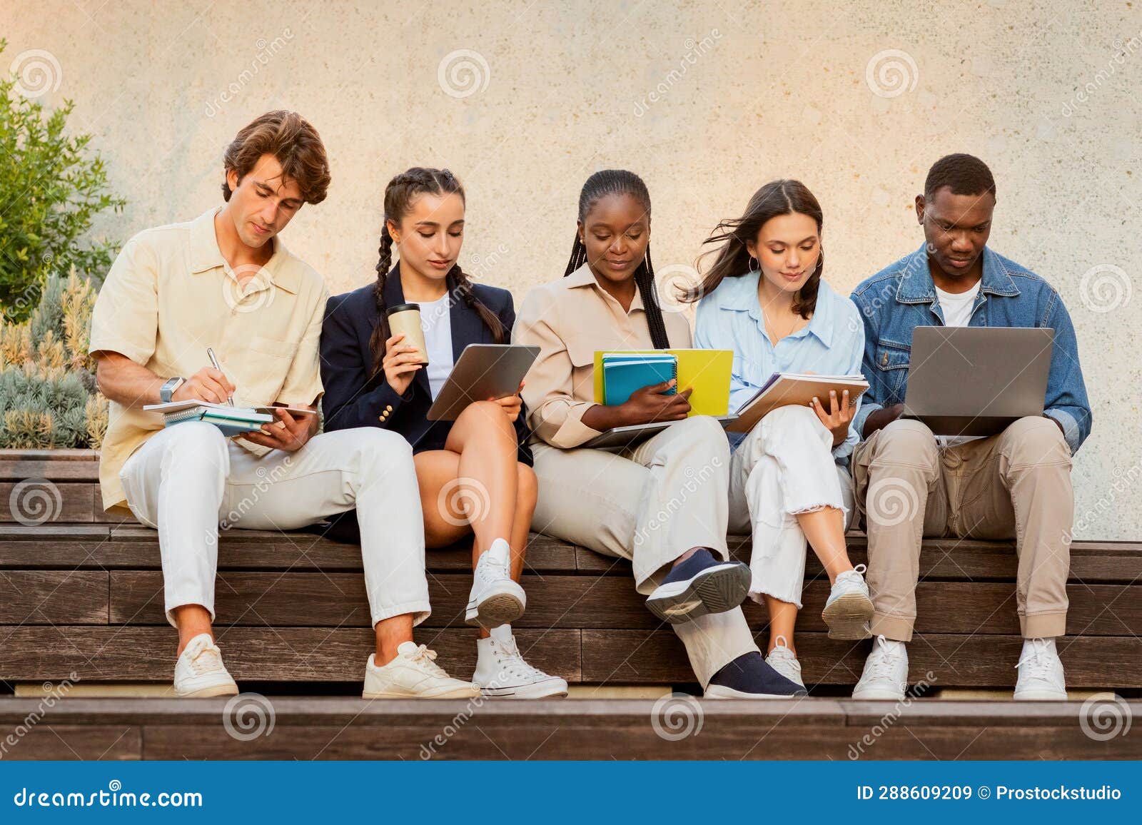 Multiracial Group Students Sitting on Bench, Getting Ready for Class ...