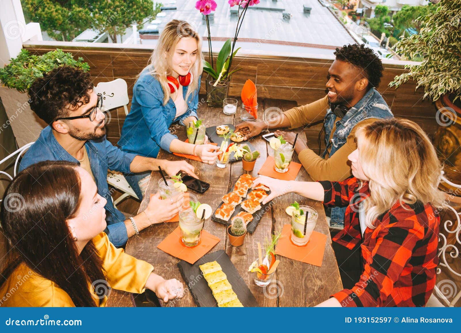 Multiracial Group Of Young Millennials Friends Talking And Dining