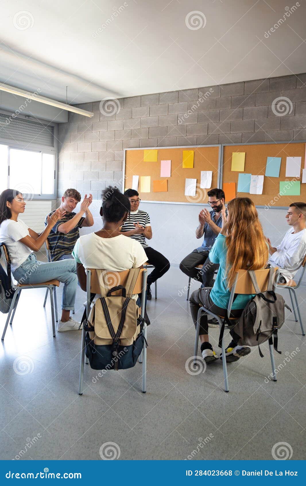 Multiracial High School Students Sitting in a Circle Clapping Together ...