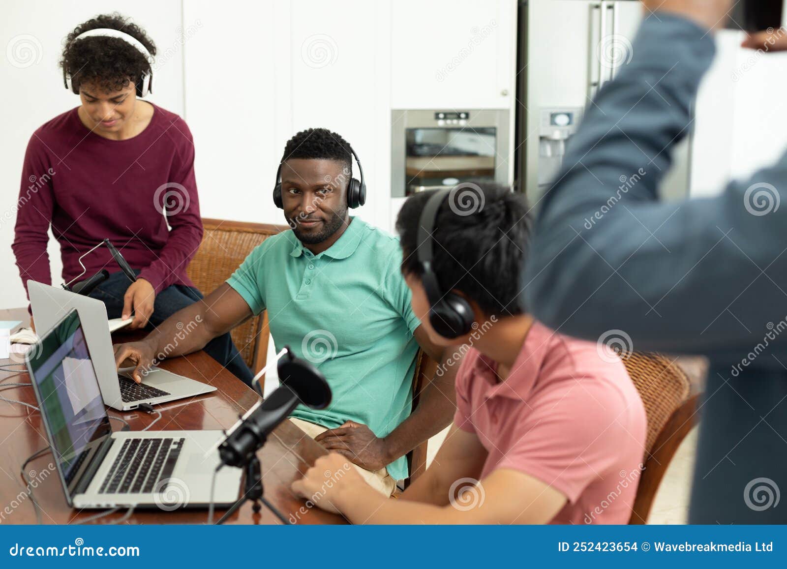 Multiracial Male Podcasters Interviewing and Recording Podcast in ...
