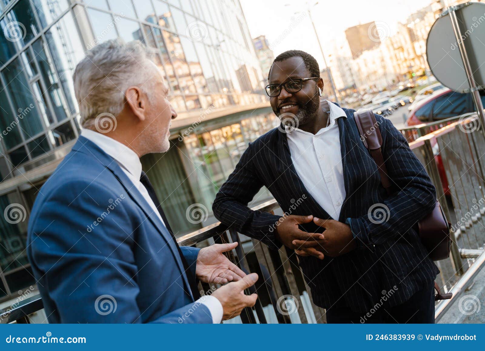 Multiracial Men Talking and Gesturing while Standing by Building Stock ...
