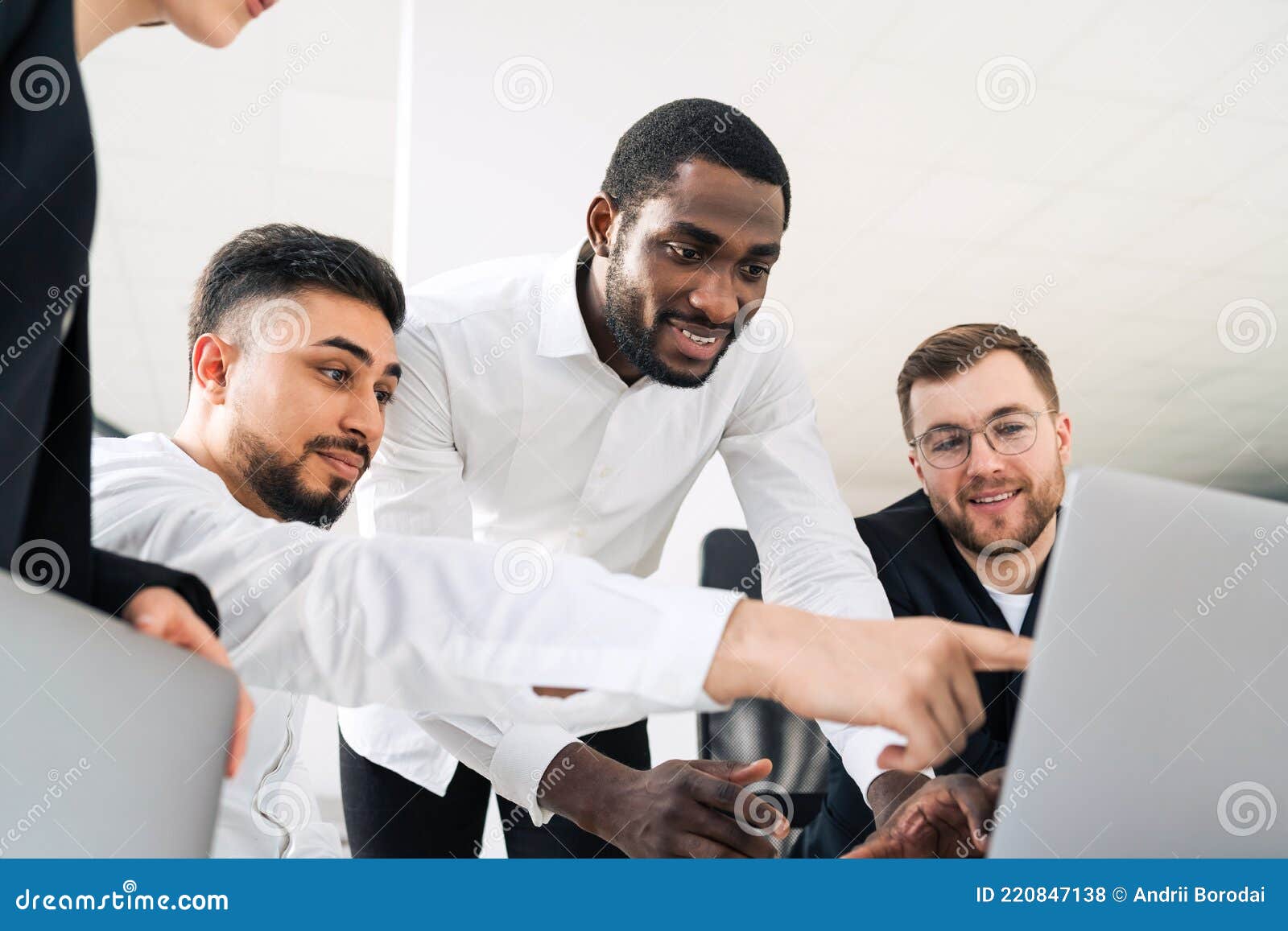 Multiracial Office Workers Looking At Laptop. Stock Photography ... Multiracial Office Workers Looking At Laptop. Stock Photography ...